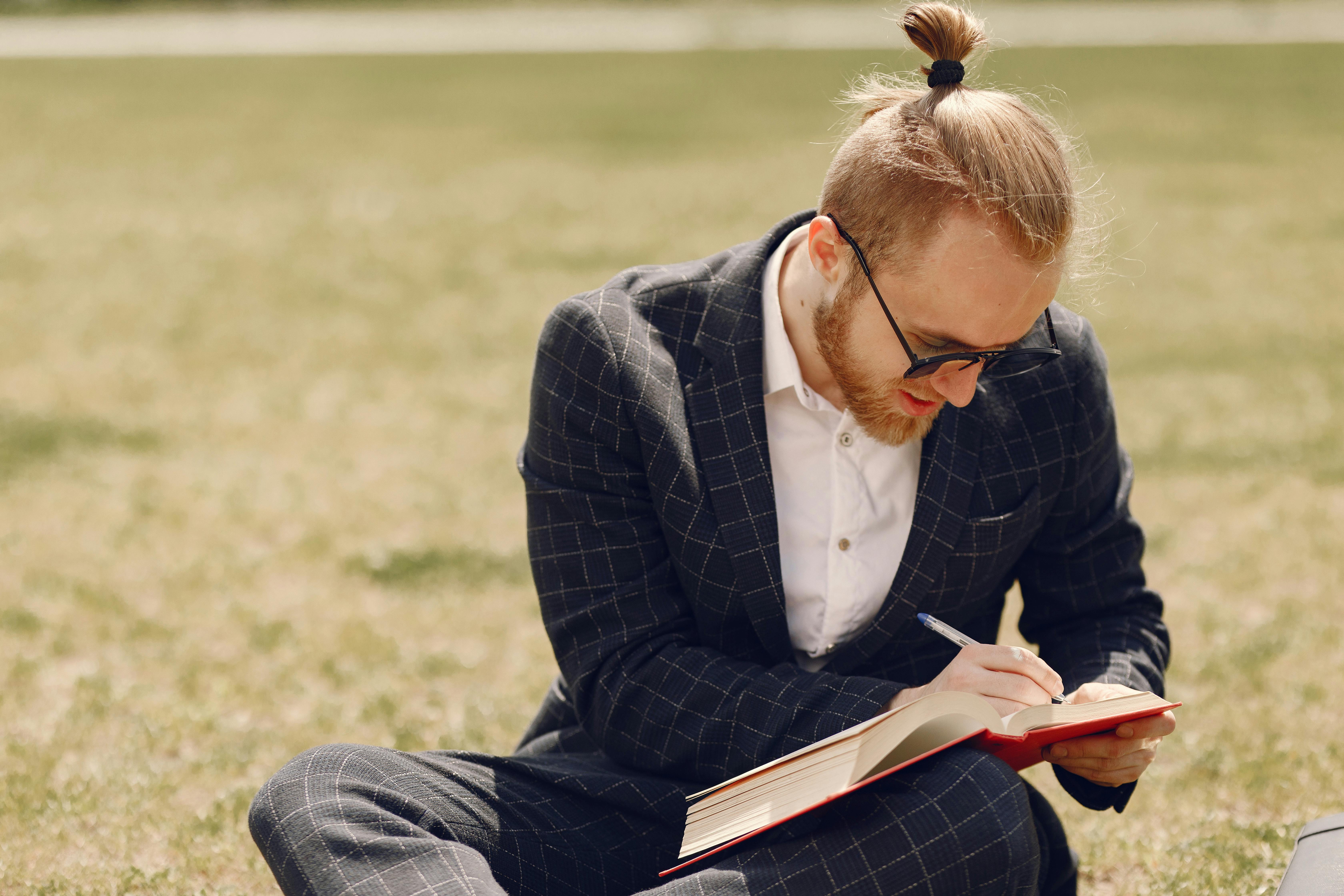 Man Handwriting in Book · Free Stock Photo