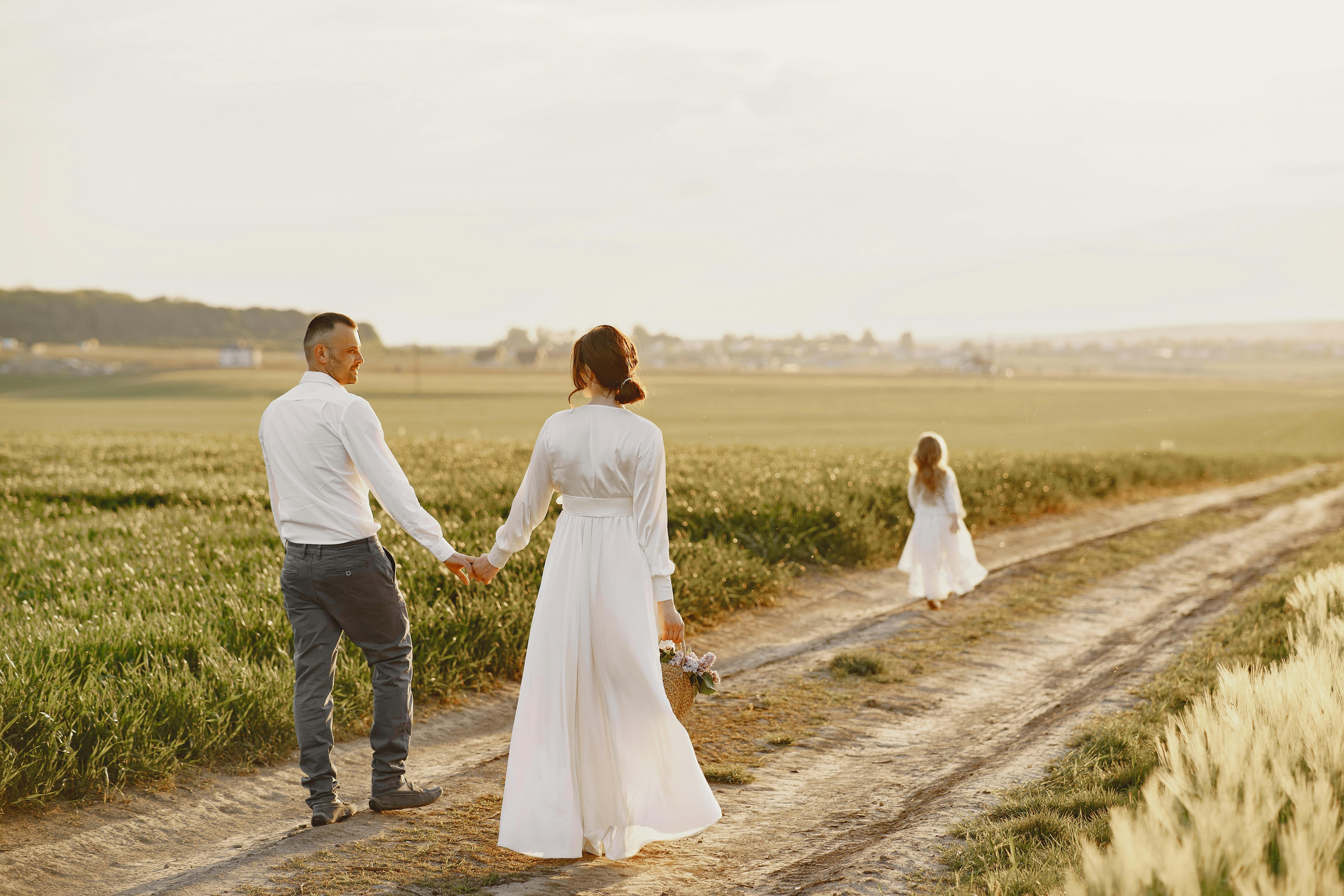 A Couple Walking on Dirt Road Holding Hands · Free Stock Photo