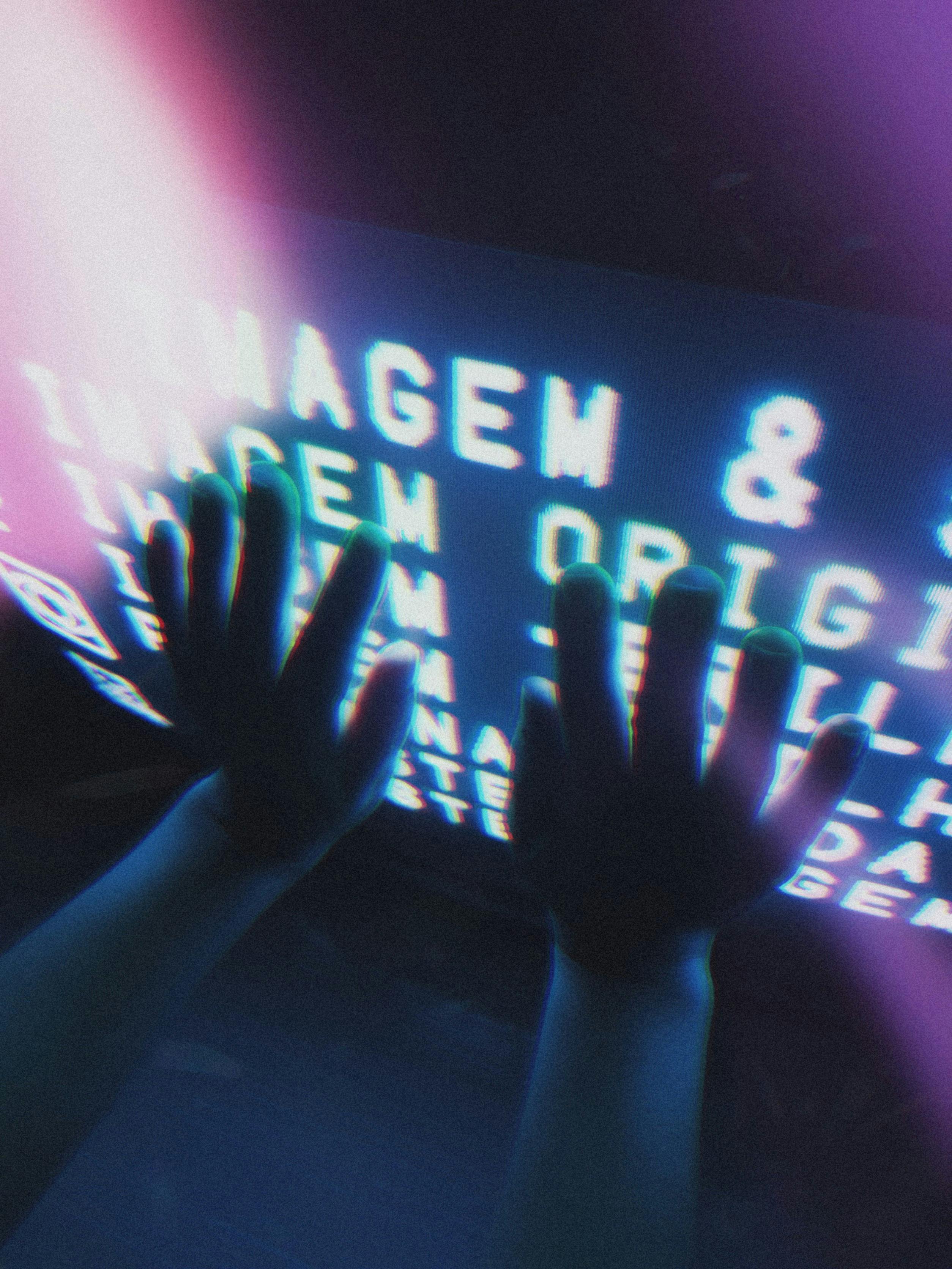 Person Holding Hands on Screen · Free Stock Photo