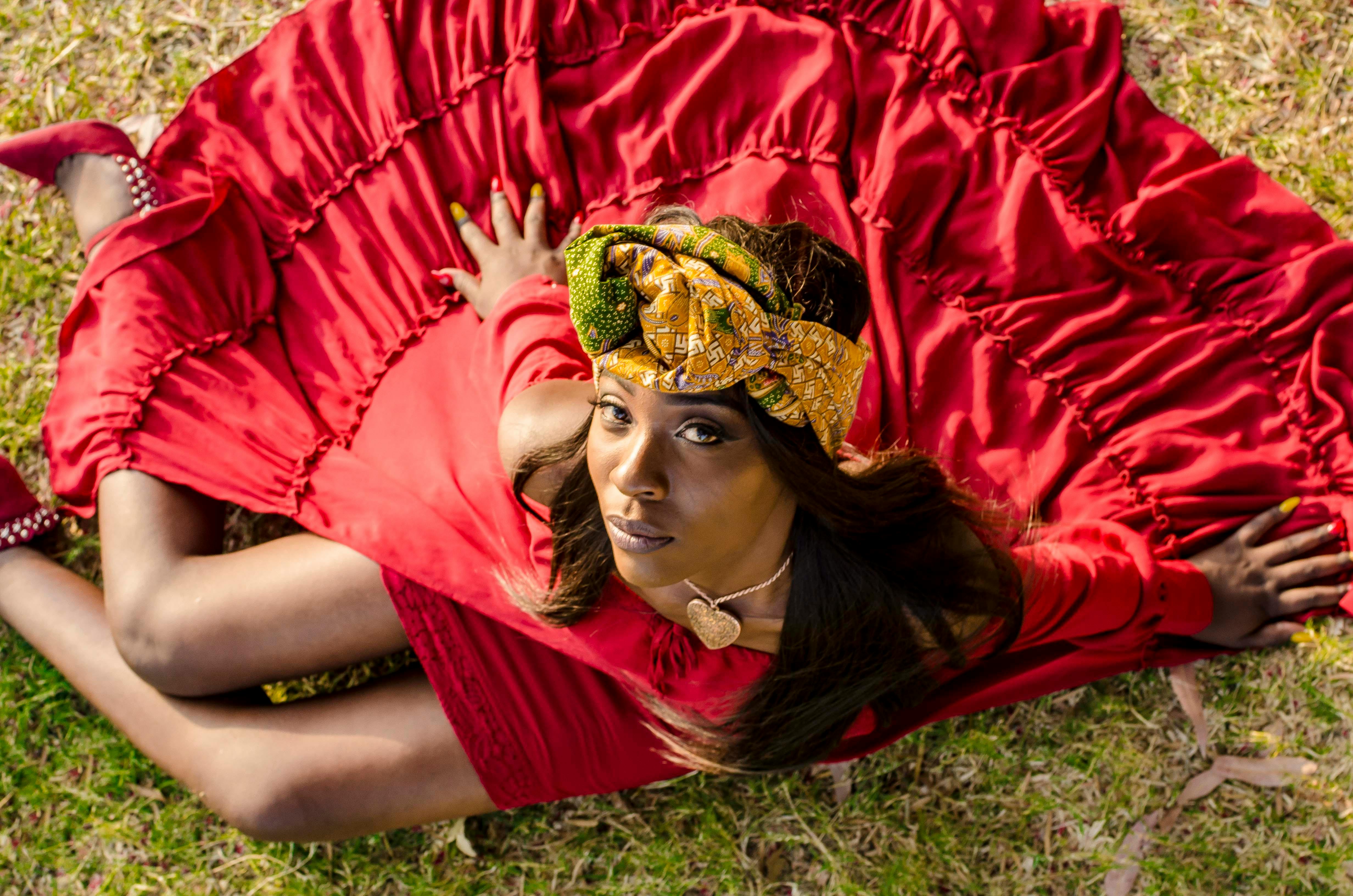 Beautiful Woman in Red Dress Wearing a Head Wrap · Free Stock Photo
