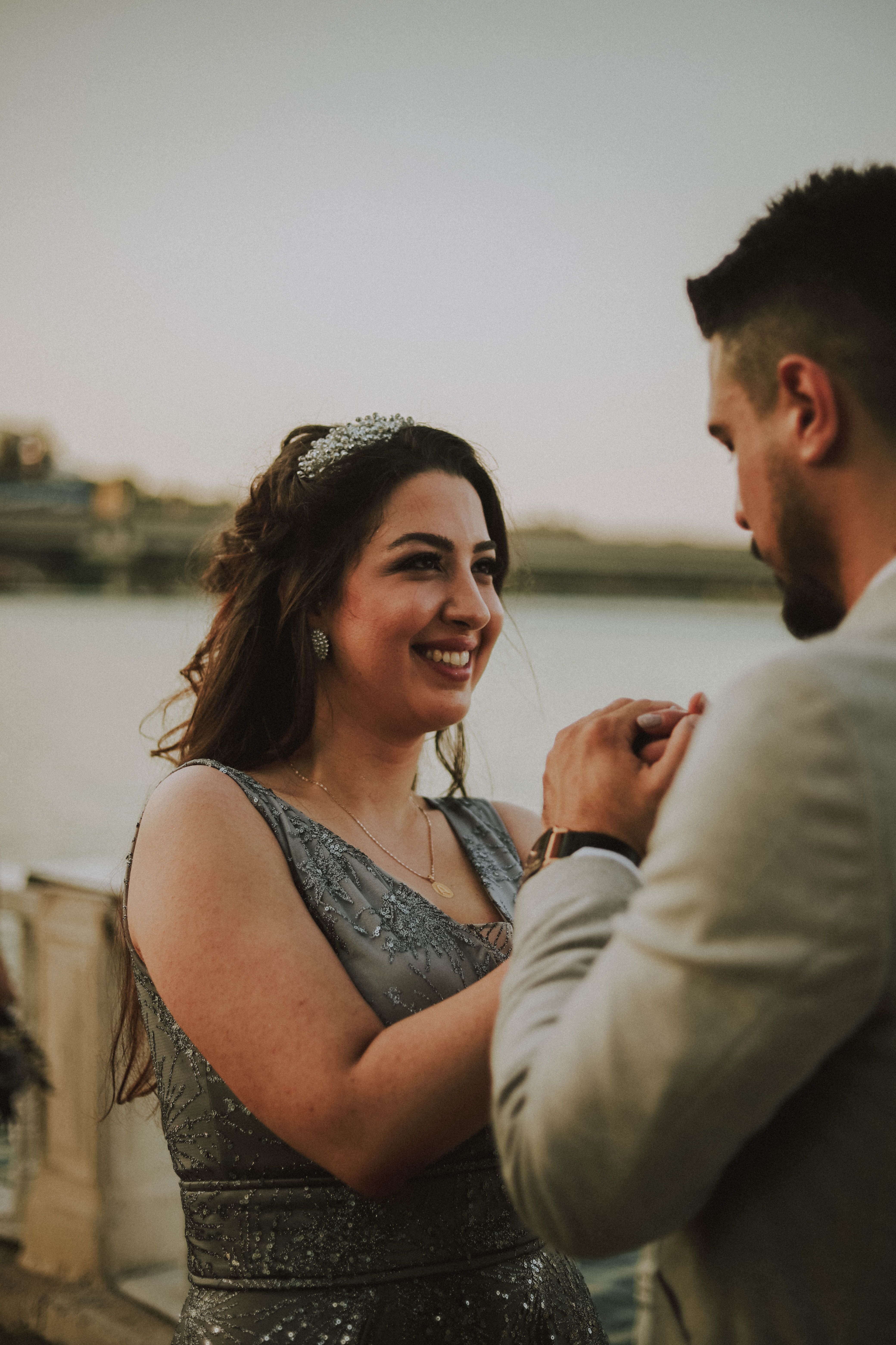 Flirty mature couple standing at metal doorway · Free Stock Photo