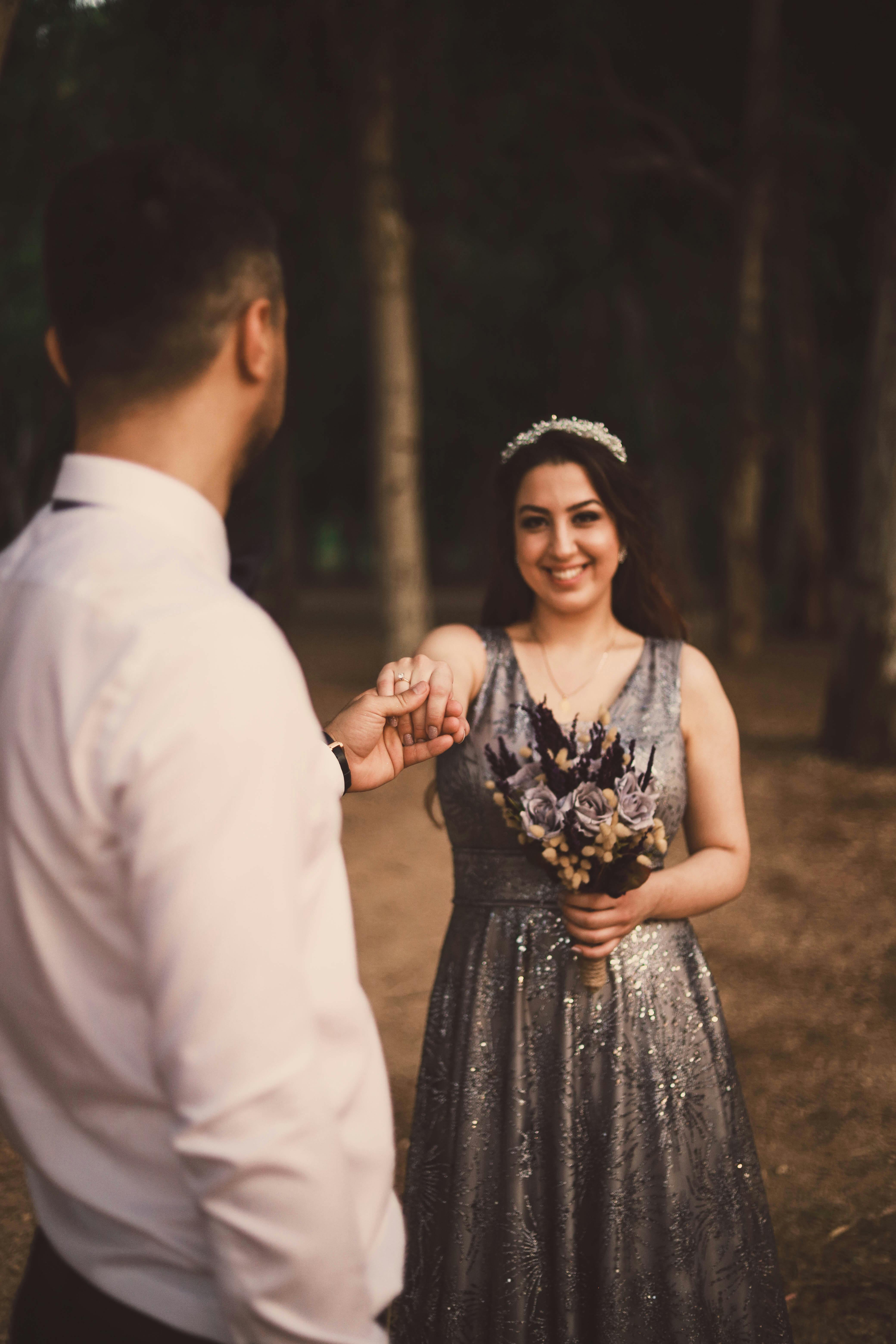 Happy bride holding hand of groom · Free Stock Photo