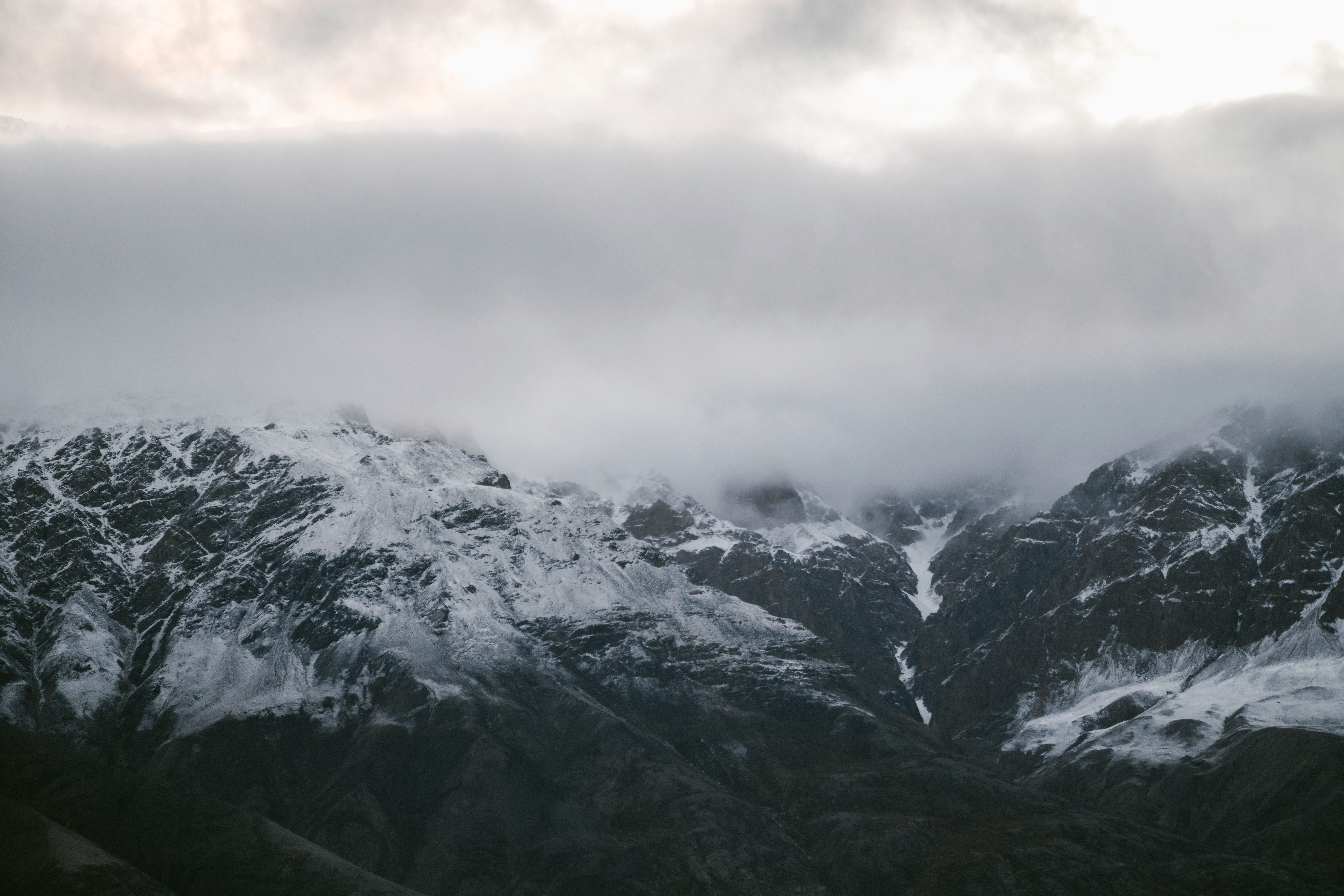 A snowy mountain covered in trees and snow · Free Stock Photo