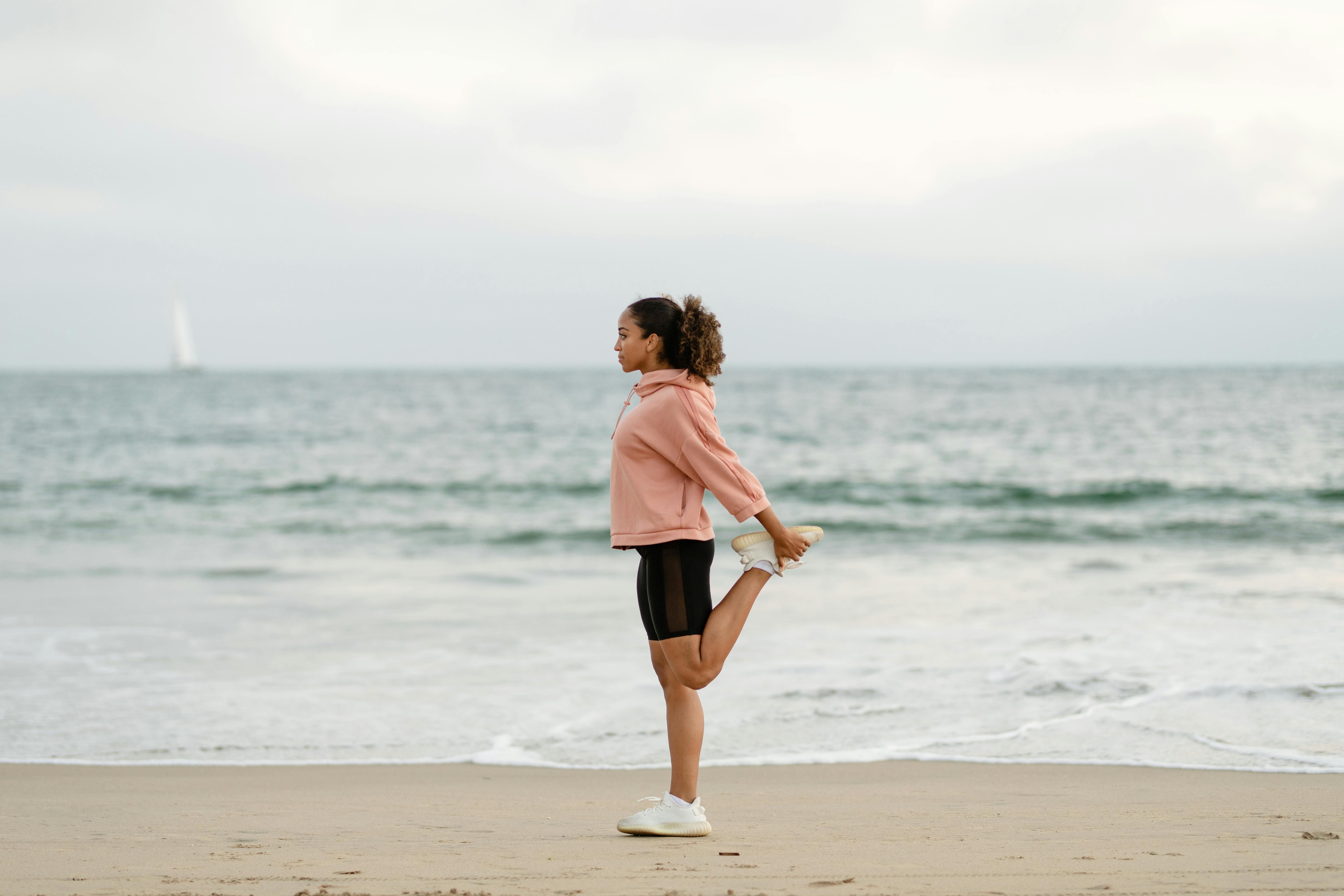 Woman Doing Stretching at the Beach · Free Stock Photo