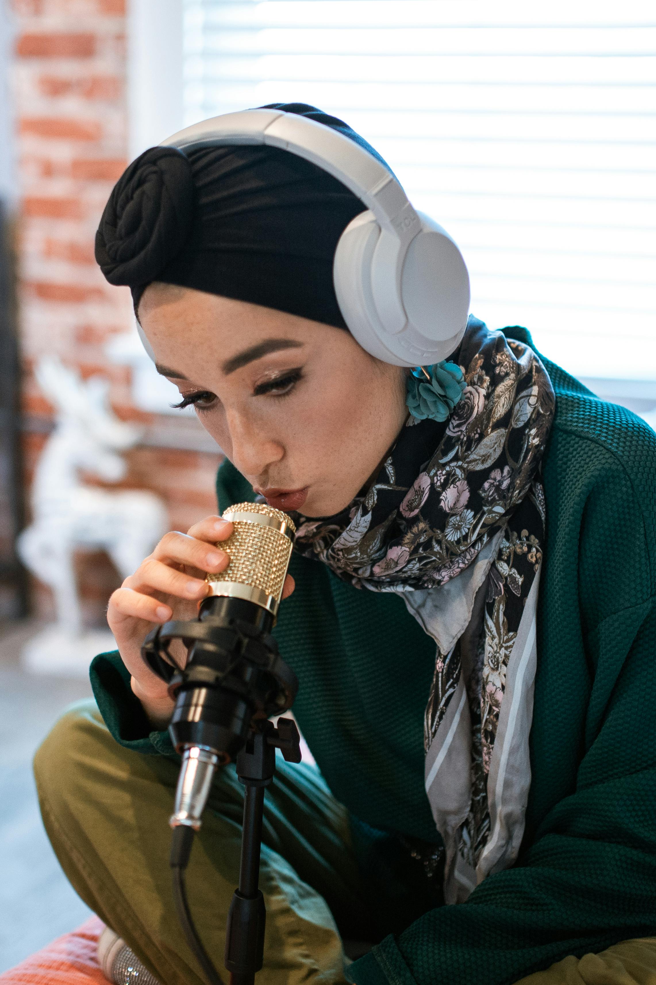 Person in Teal Blazer Holding Microphone · Free Stock Photo