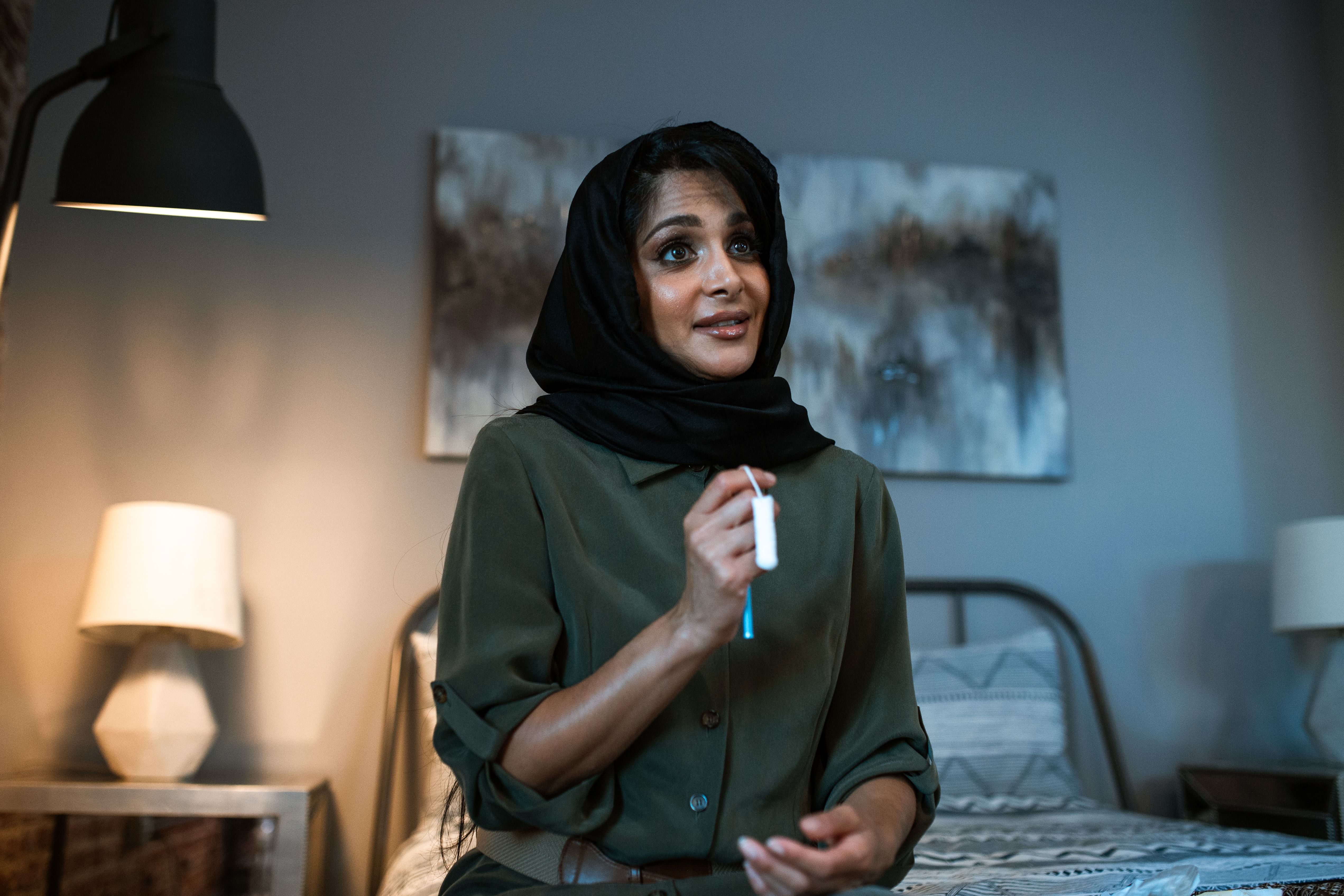 Woman in a Hijab Holding a Tampon · Free Stock Photo