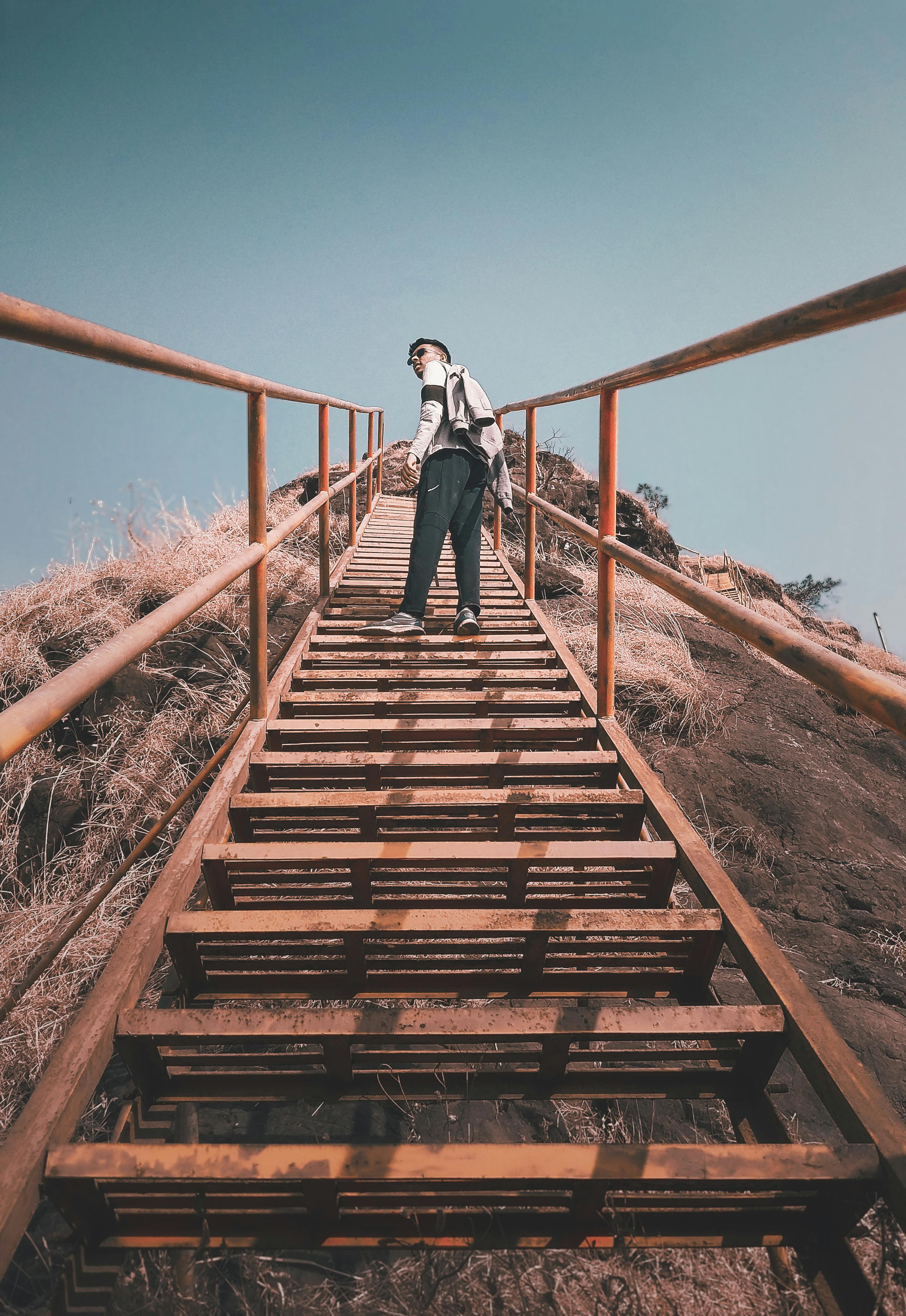 Man Walking on Metal Steps · Free Stock Photo