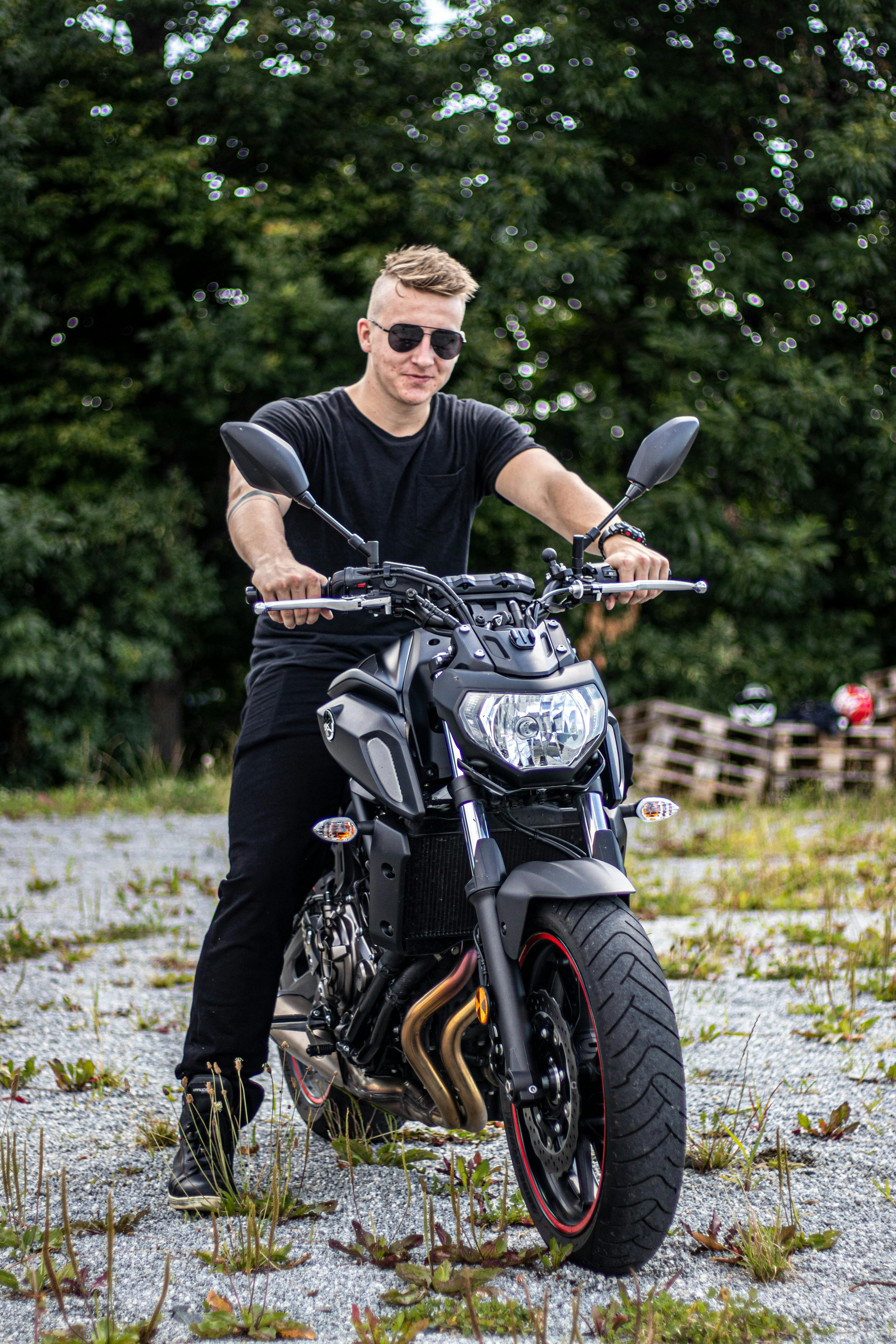 Man sitting on motorbike and smiling · Free Stock Photo