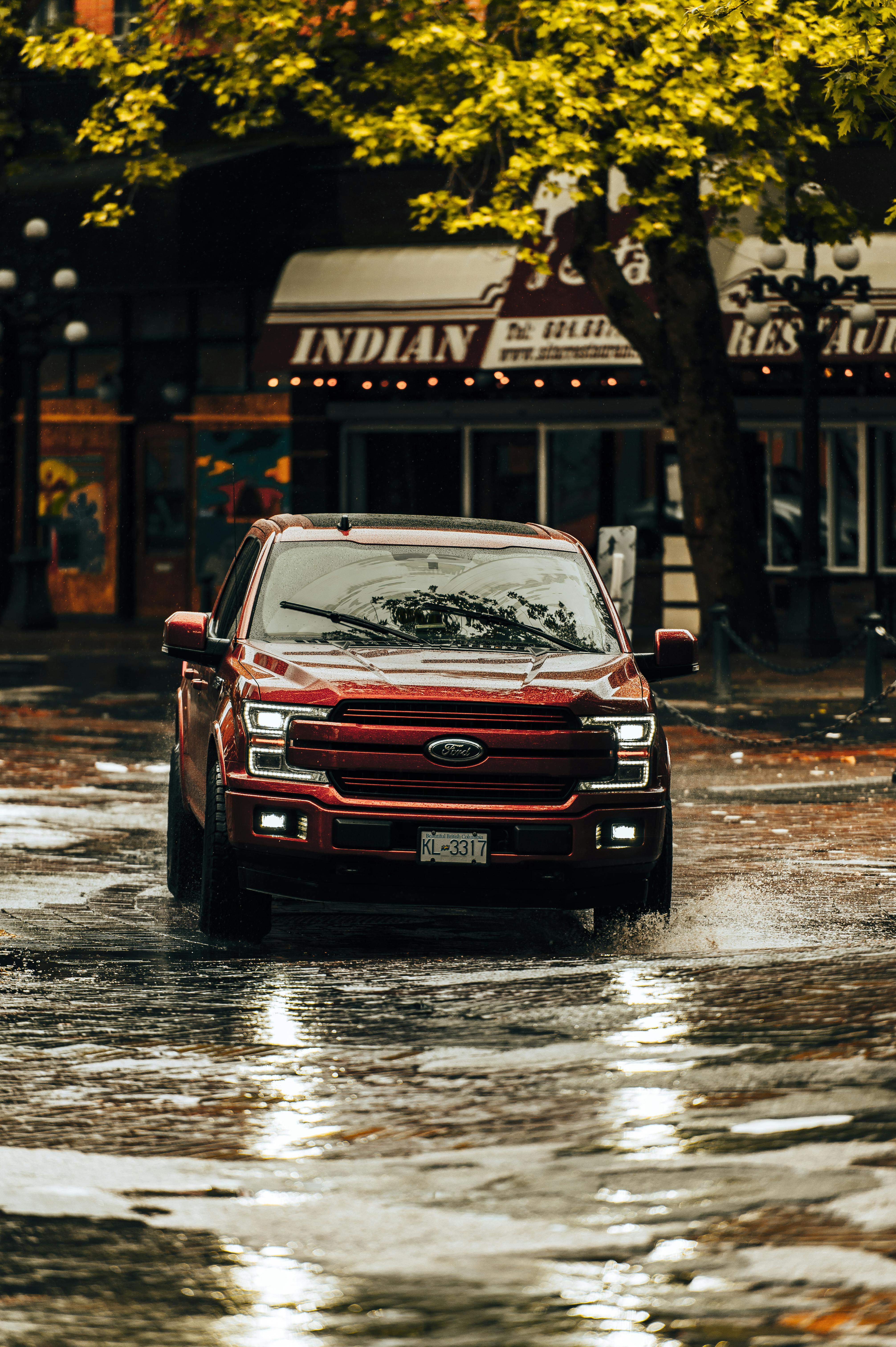 A Red Vehicle on a Flooded Road · Free Stock Photo