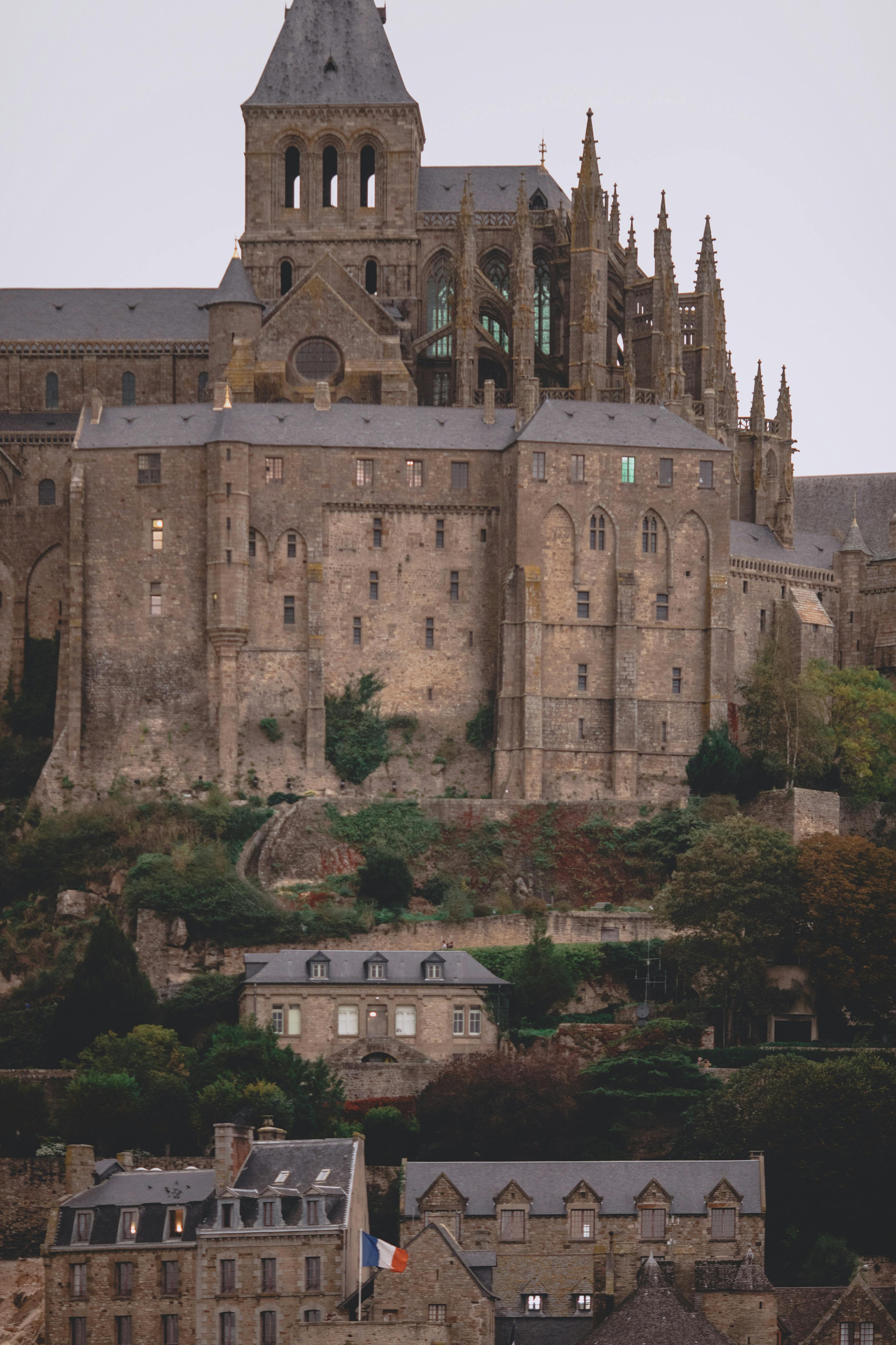 Exterior of ancient stone Gothic monastery against overcast sky · Free ...