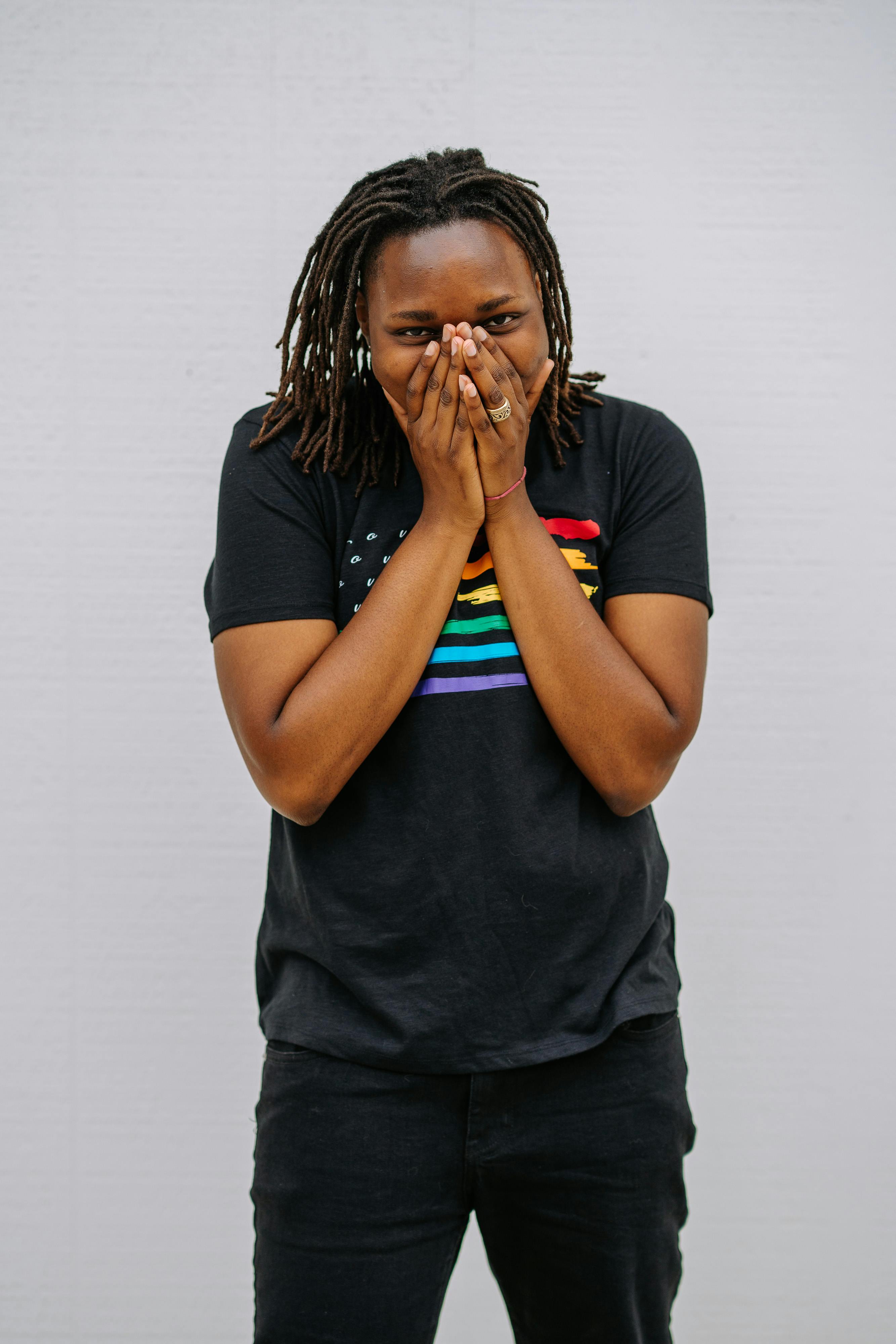 A Man Covering his Mouth while Leaning on a Mirror · Free Stock Photo