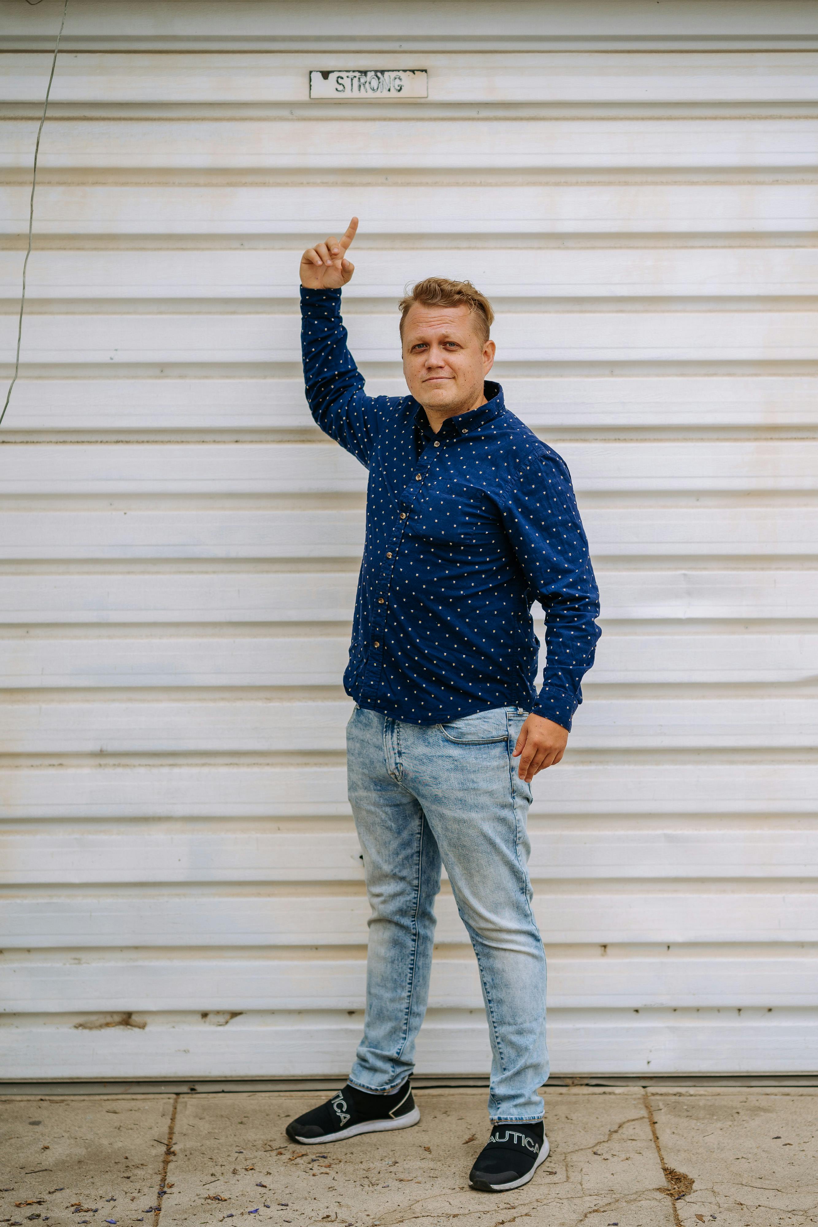 Man in Blue Long Sleeves with Arm Raised · Free Stock Photo
