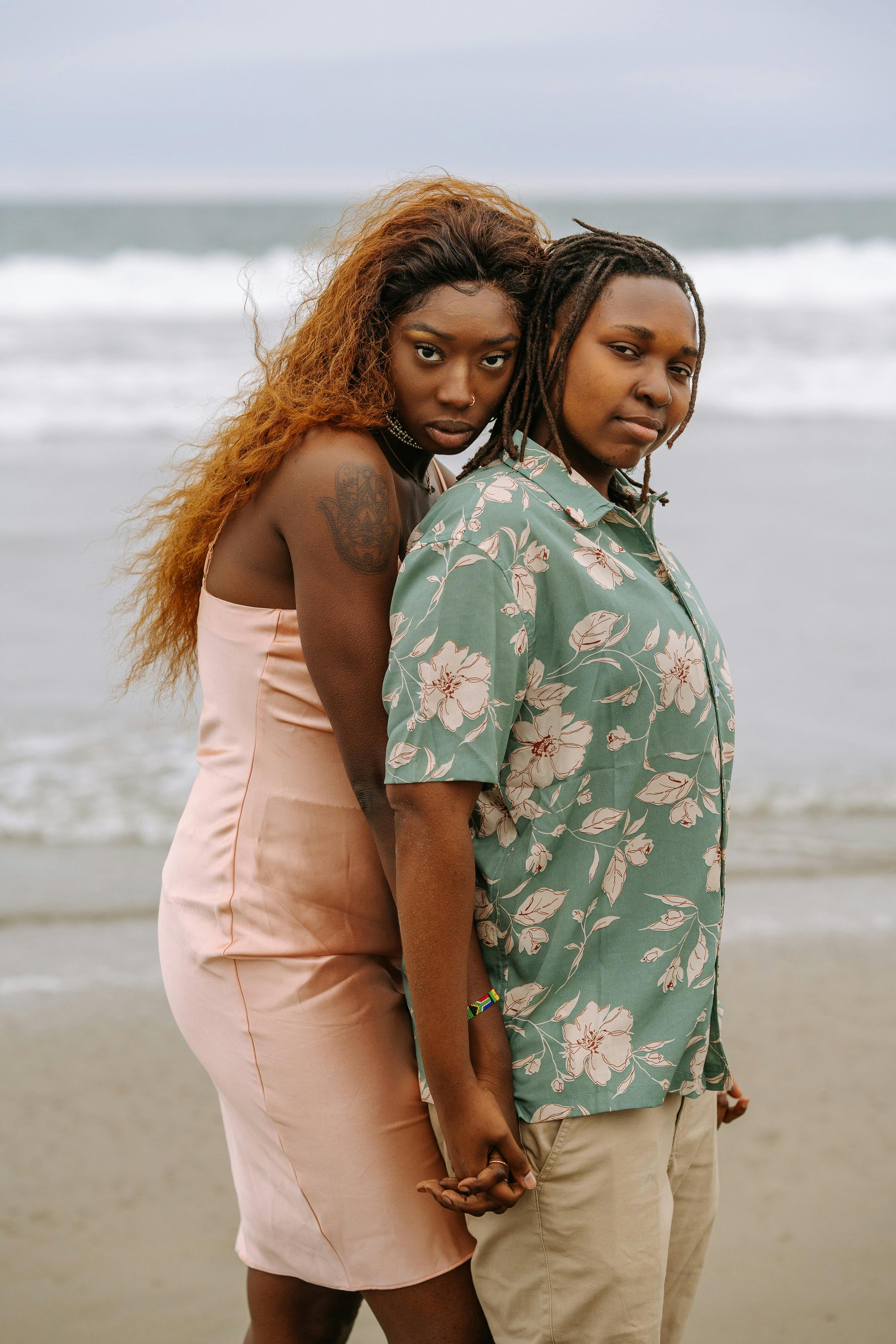 A Couple Standing Back to Back · Free Stock Photo