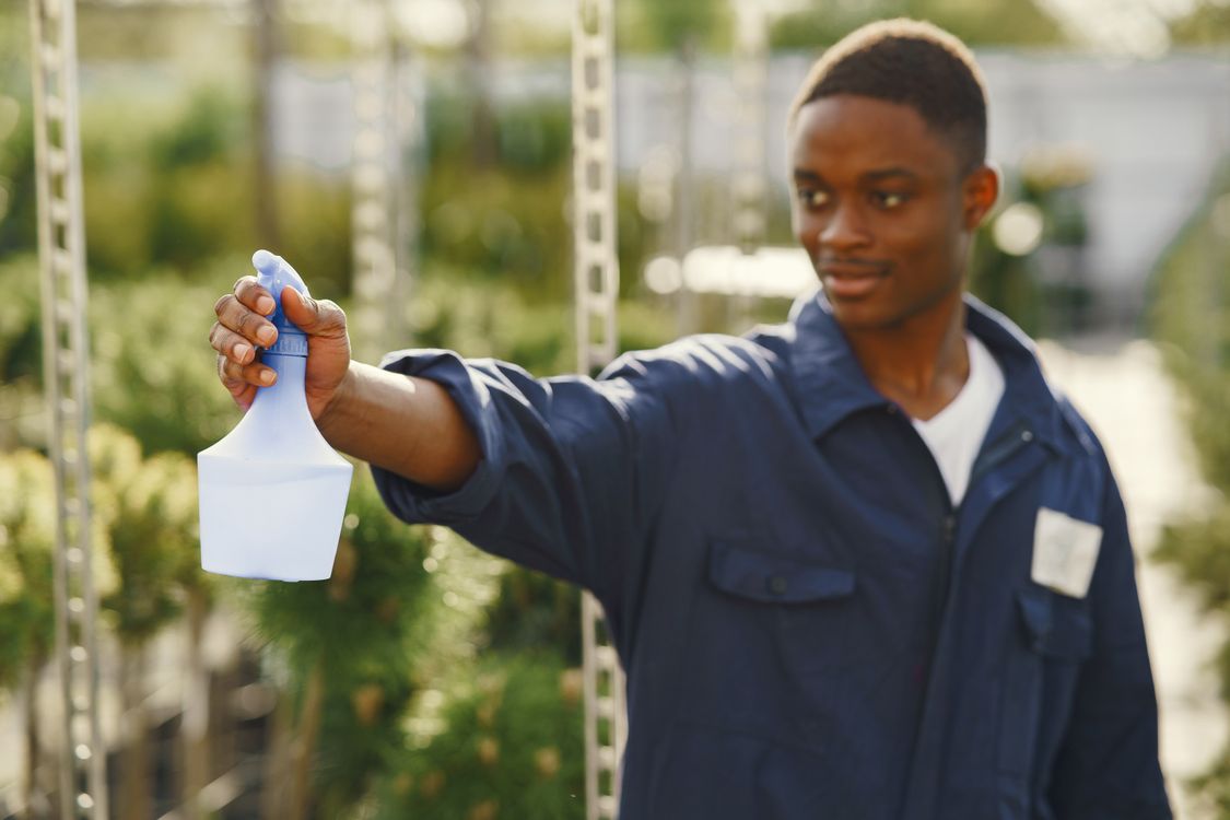 Man Holding A Spray Bottle Free Stock Photo man-holding-a-spray-bottle-free-stock-photo
