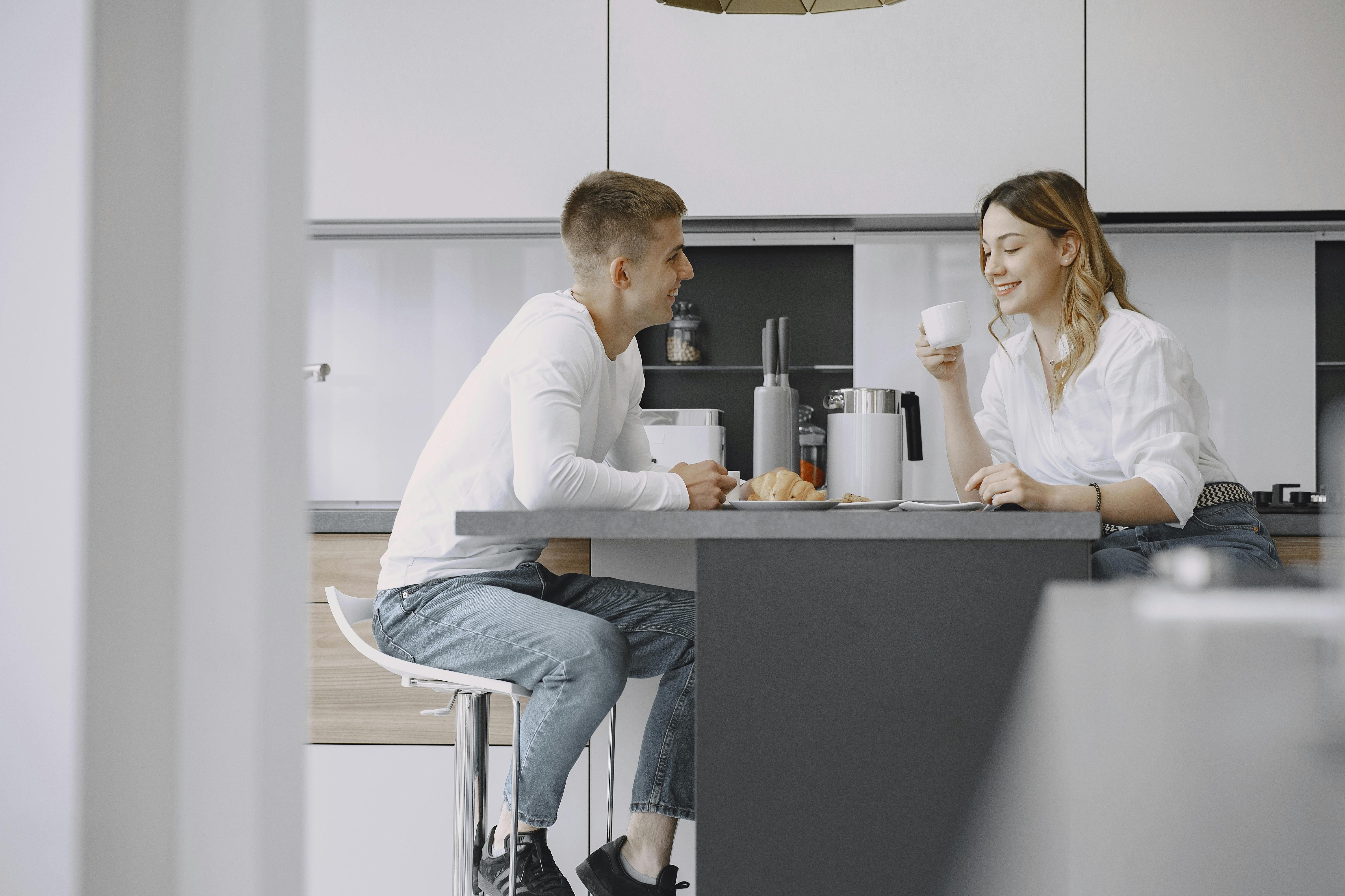 Couple sitting beside Counter Top · Free Stock Photo