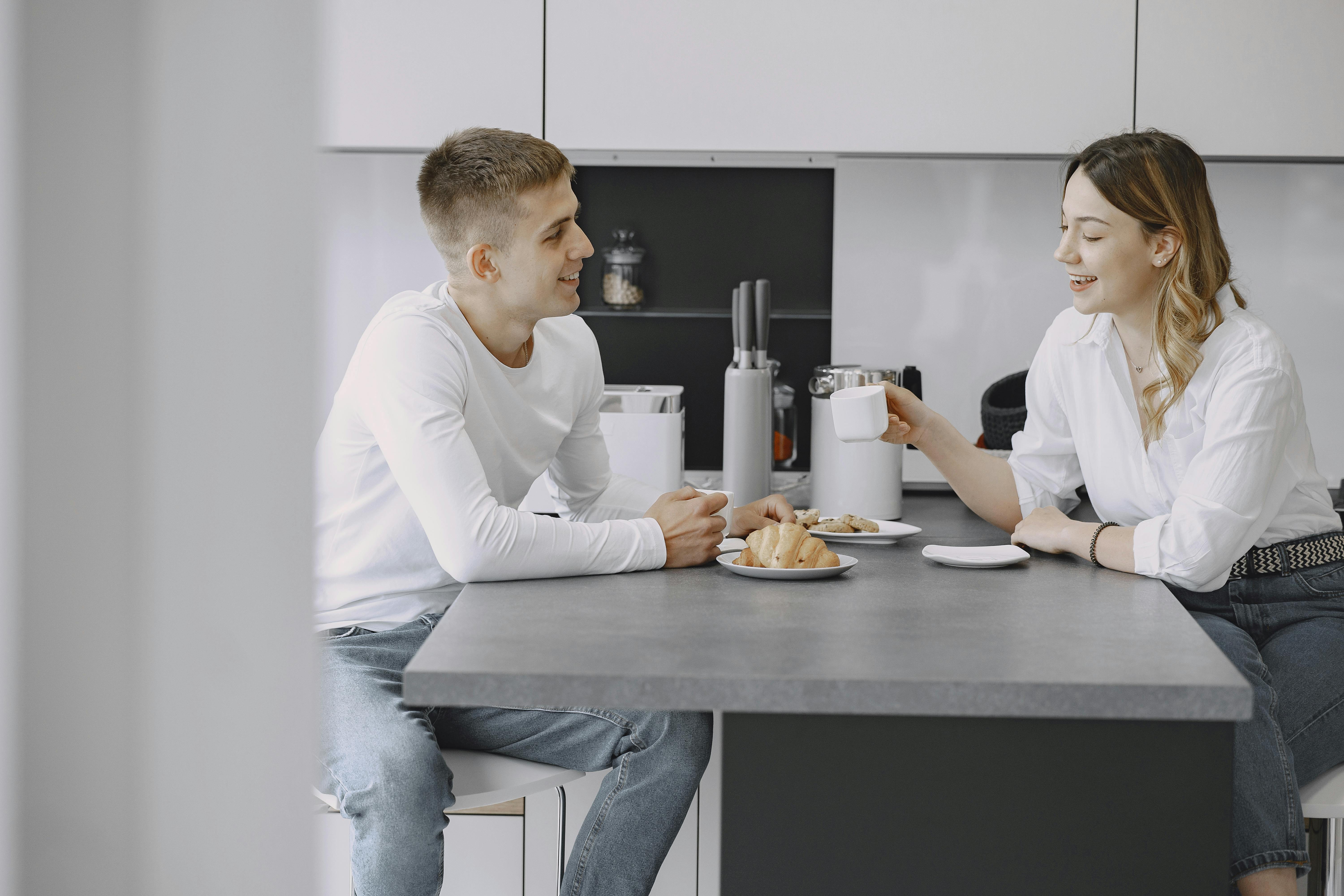 Couple sitting beside Counter Top · Free Stock Photo