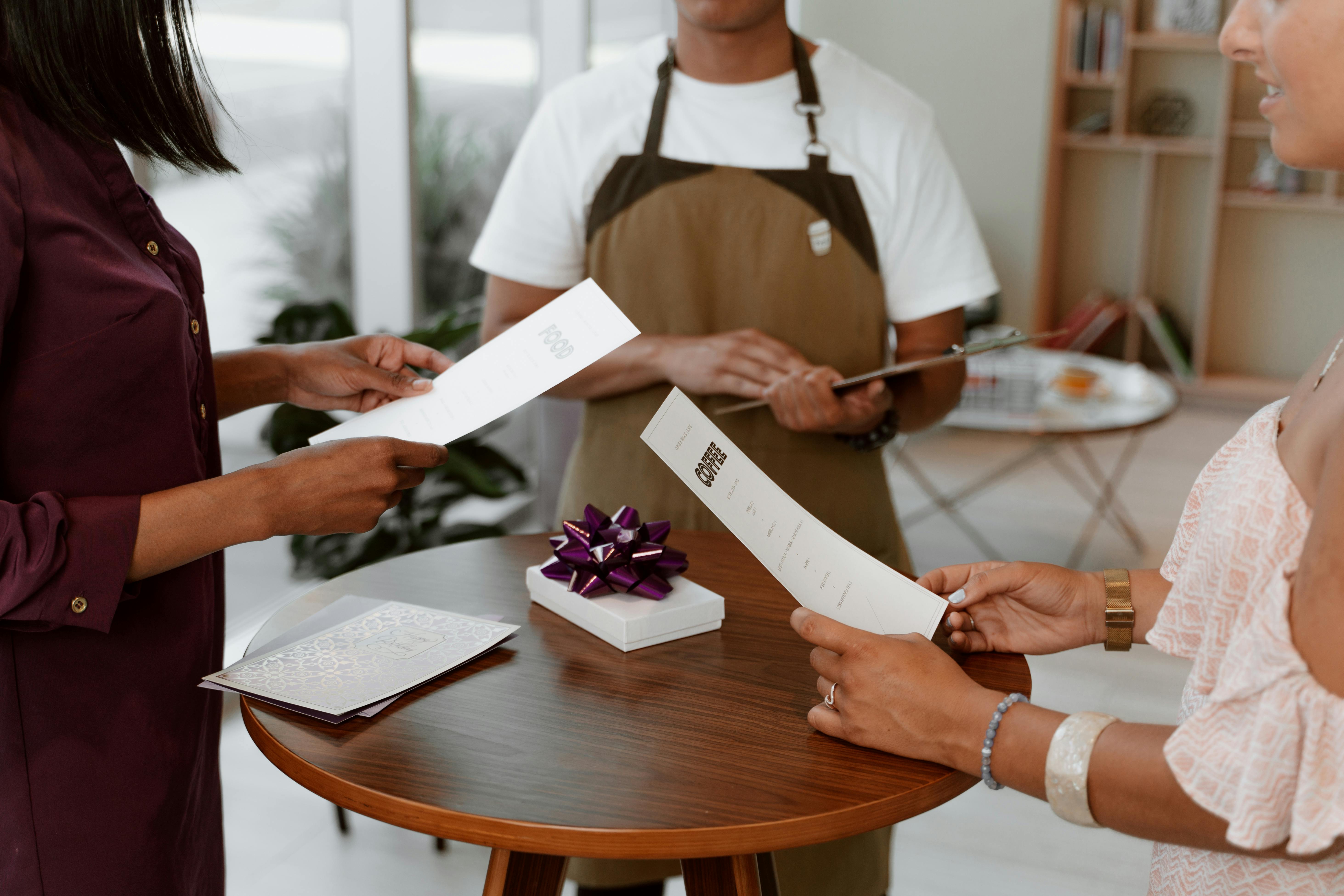 Close-up Shot of People Exchanging Gifts and Cards · Free Stock Photo