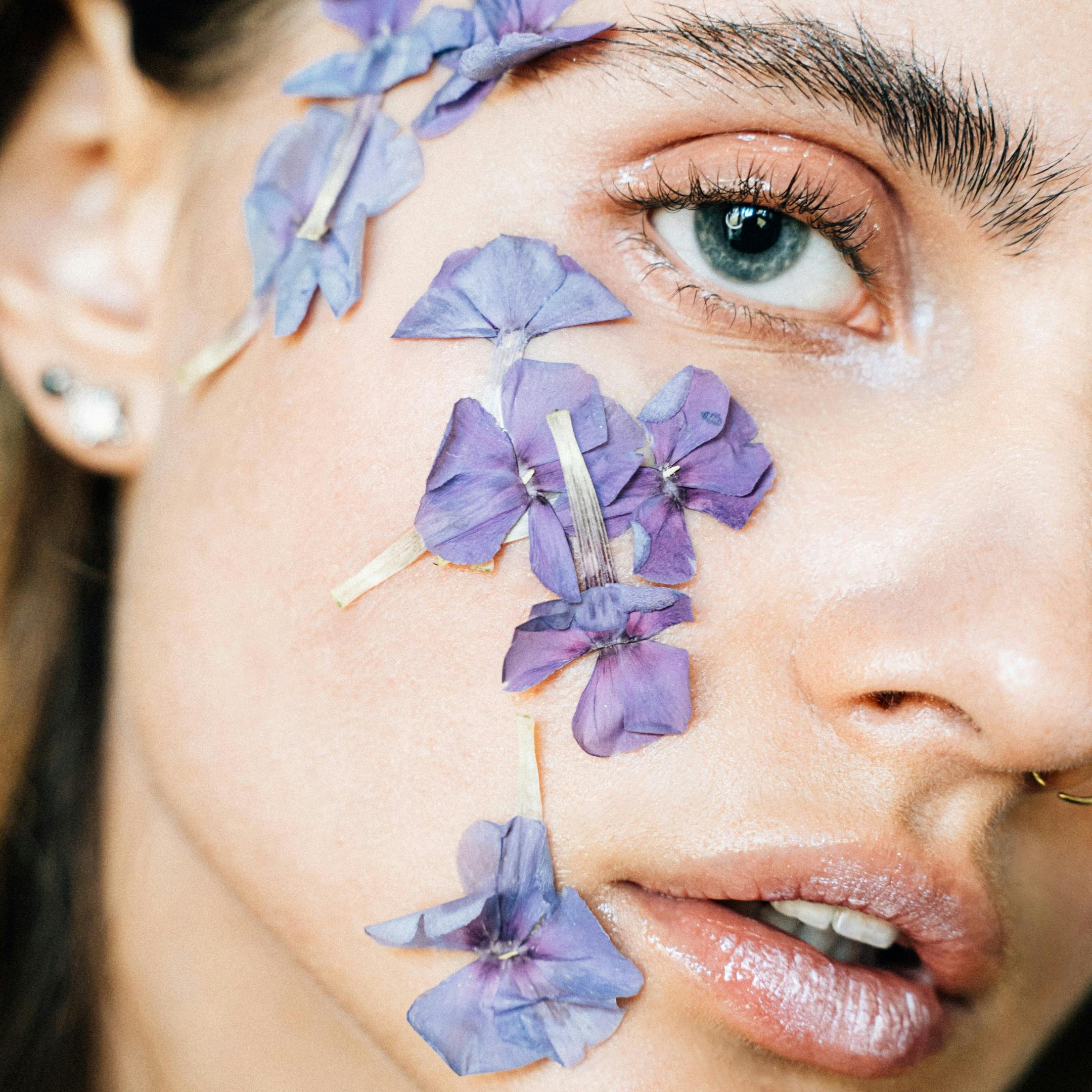 Purple Flowers on a Woman's Face · Free Stock Photo