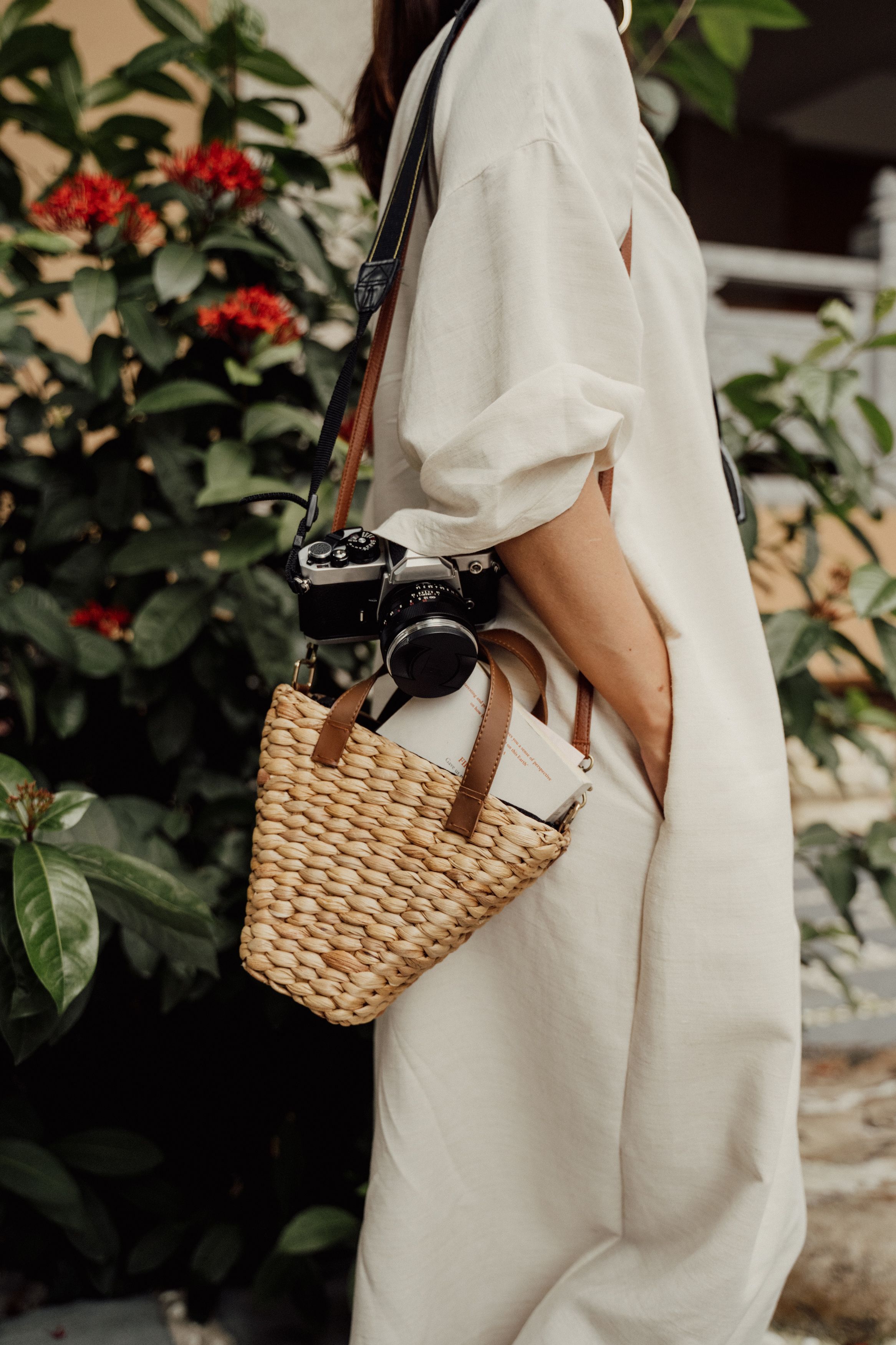Woman in White Dress Carrying Camera and Leather Strap Woven Handbag ...