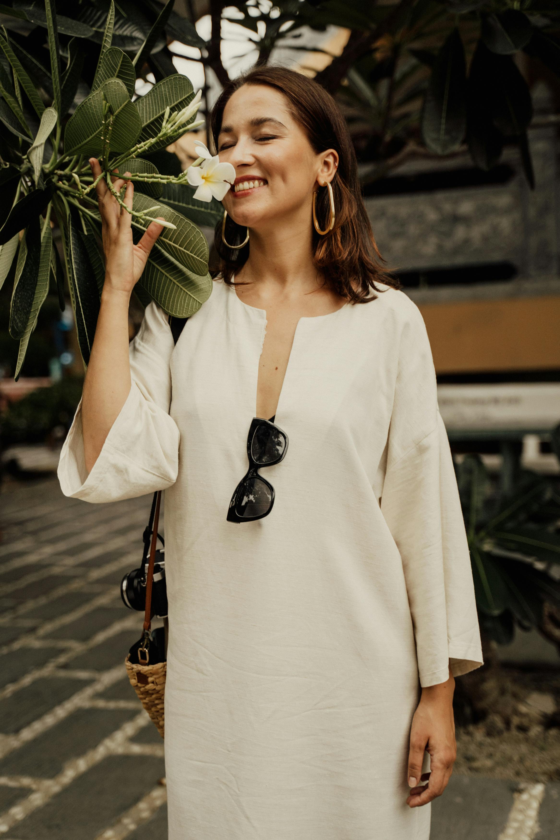 Woman Smelling Red Flowers while Her Eyes are Closed · Free Stock Photo