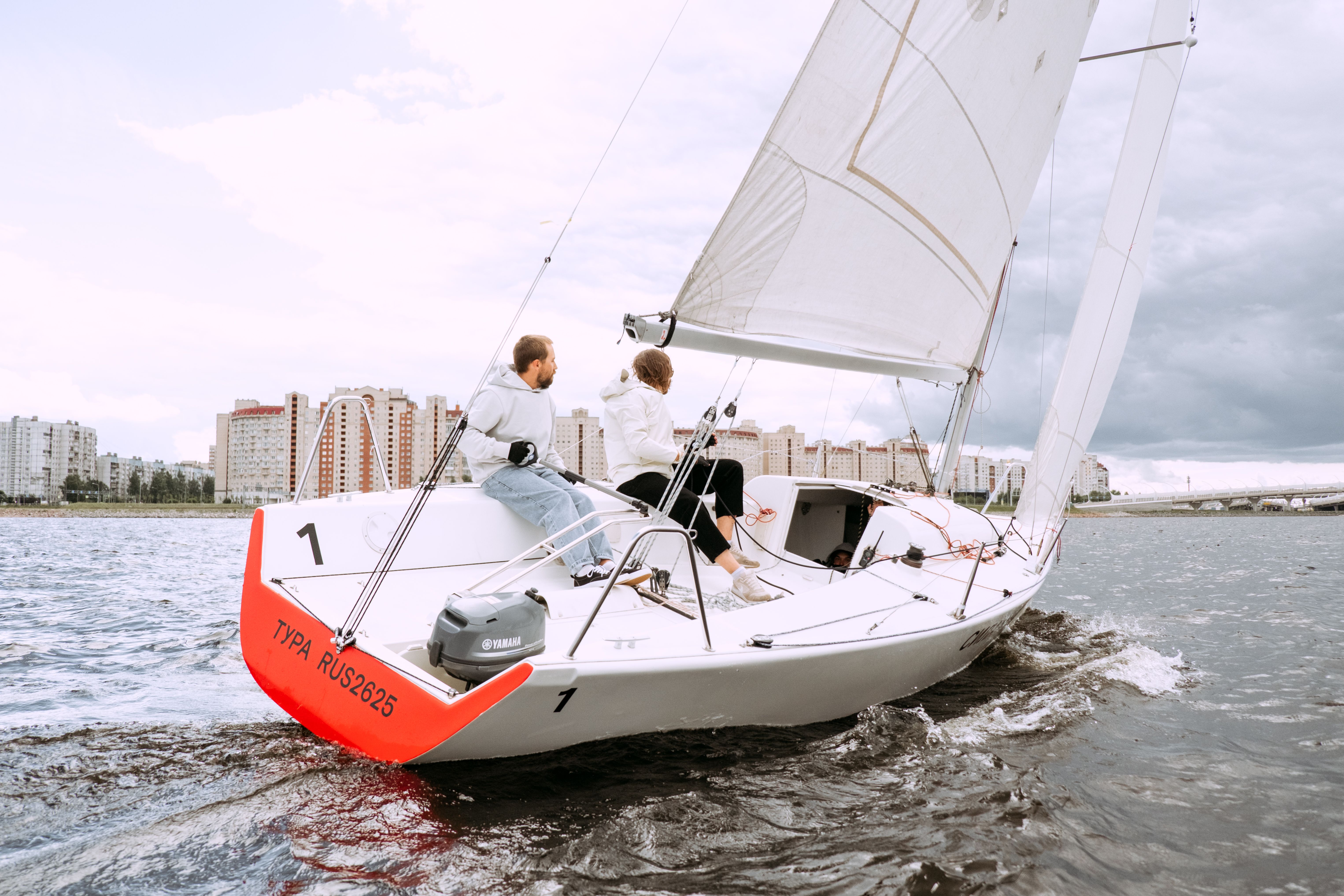 Man in White T-shirt and Black Pants Standing on White Sail Boat · Free ...