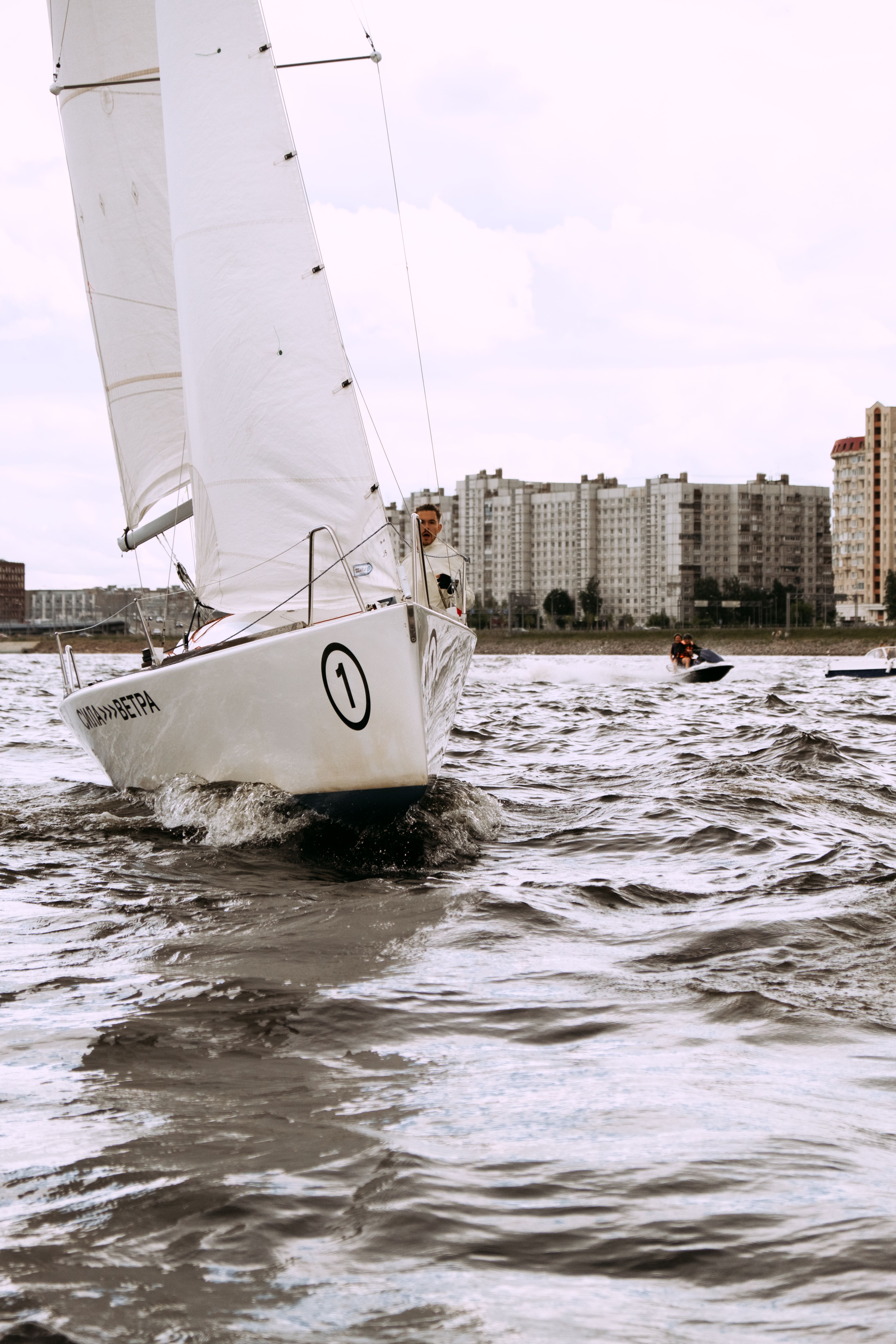 Man in White T-shirt and Black Pants Standing on White Sail Boat · Free ...