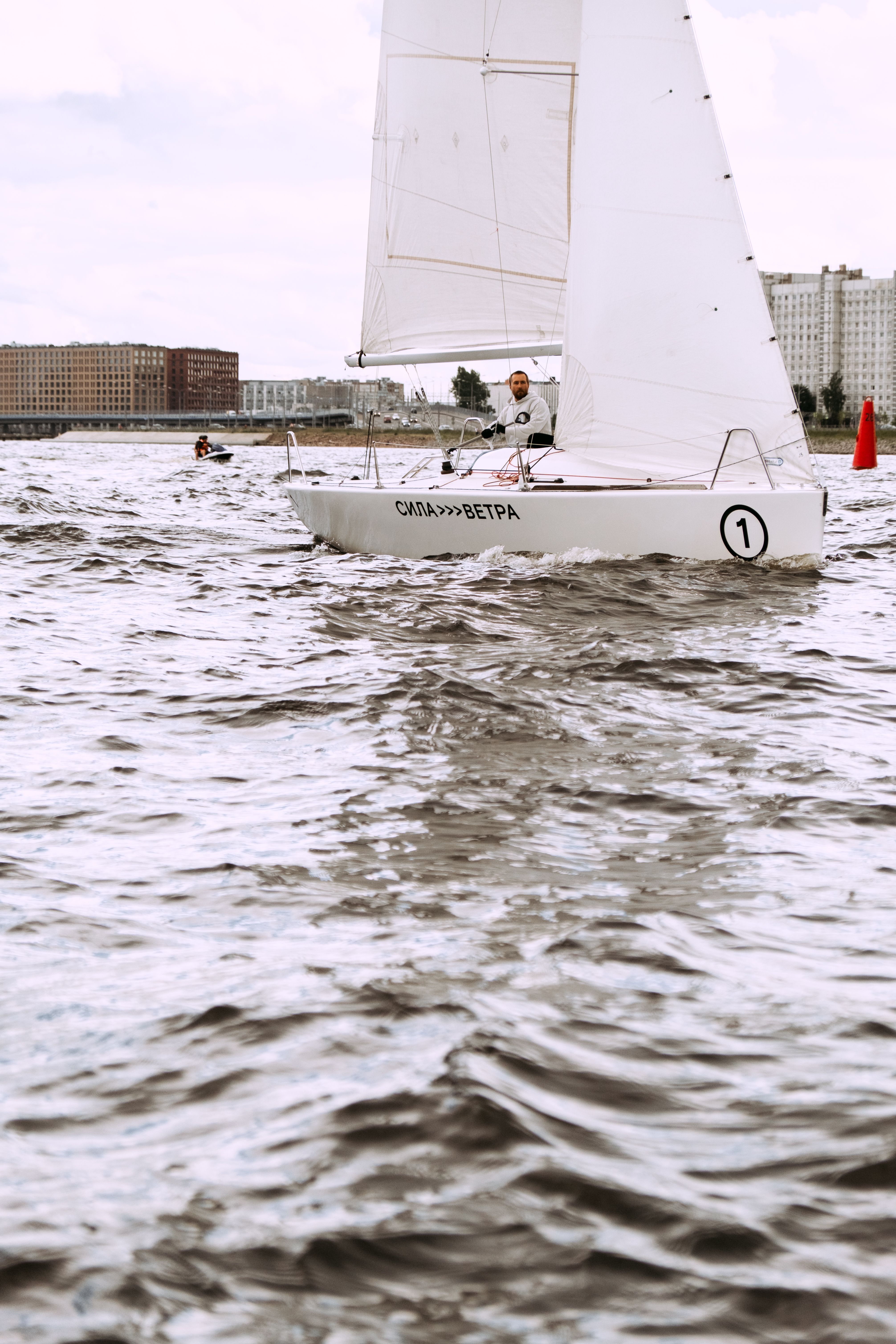 Man in White T-shirt and Black Pants Standing on White Sail Boat · Free ...