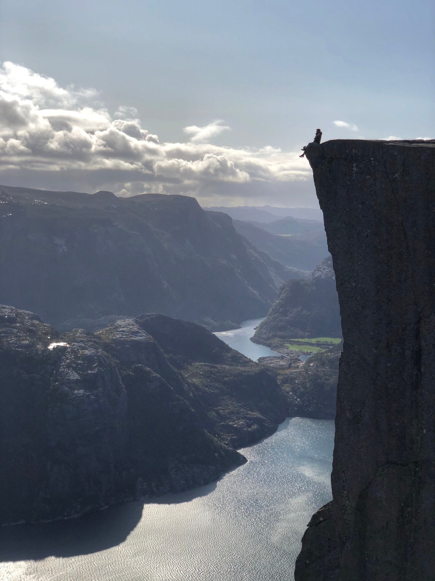 A Person Sitting on the Edge of a Cliff · Free Stock Photo