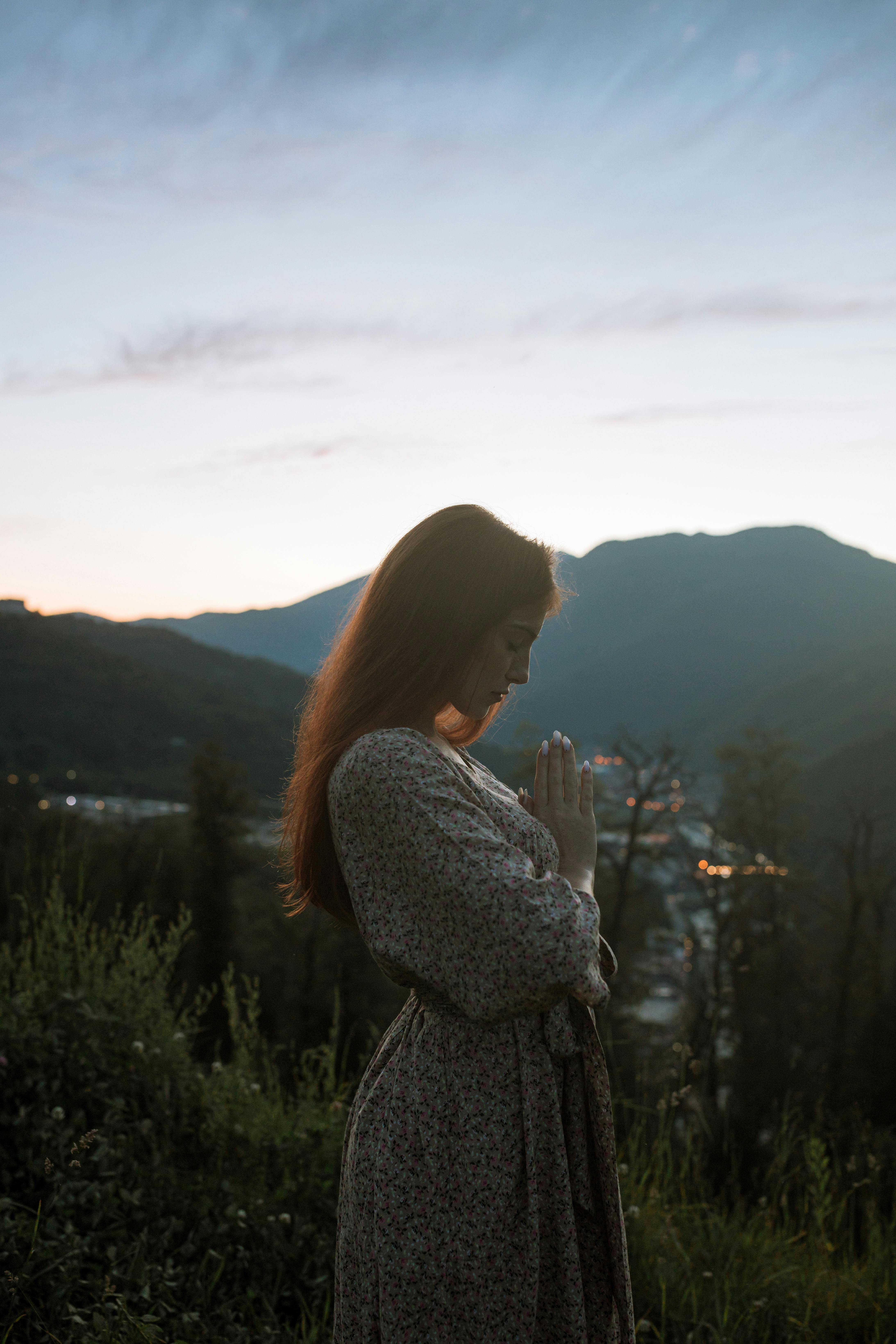 Woman Standing while Praying Outdoors · Free Stock Photo
