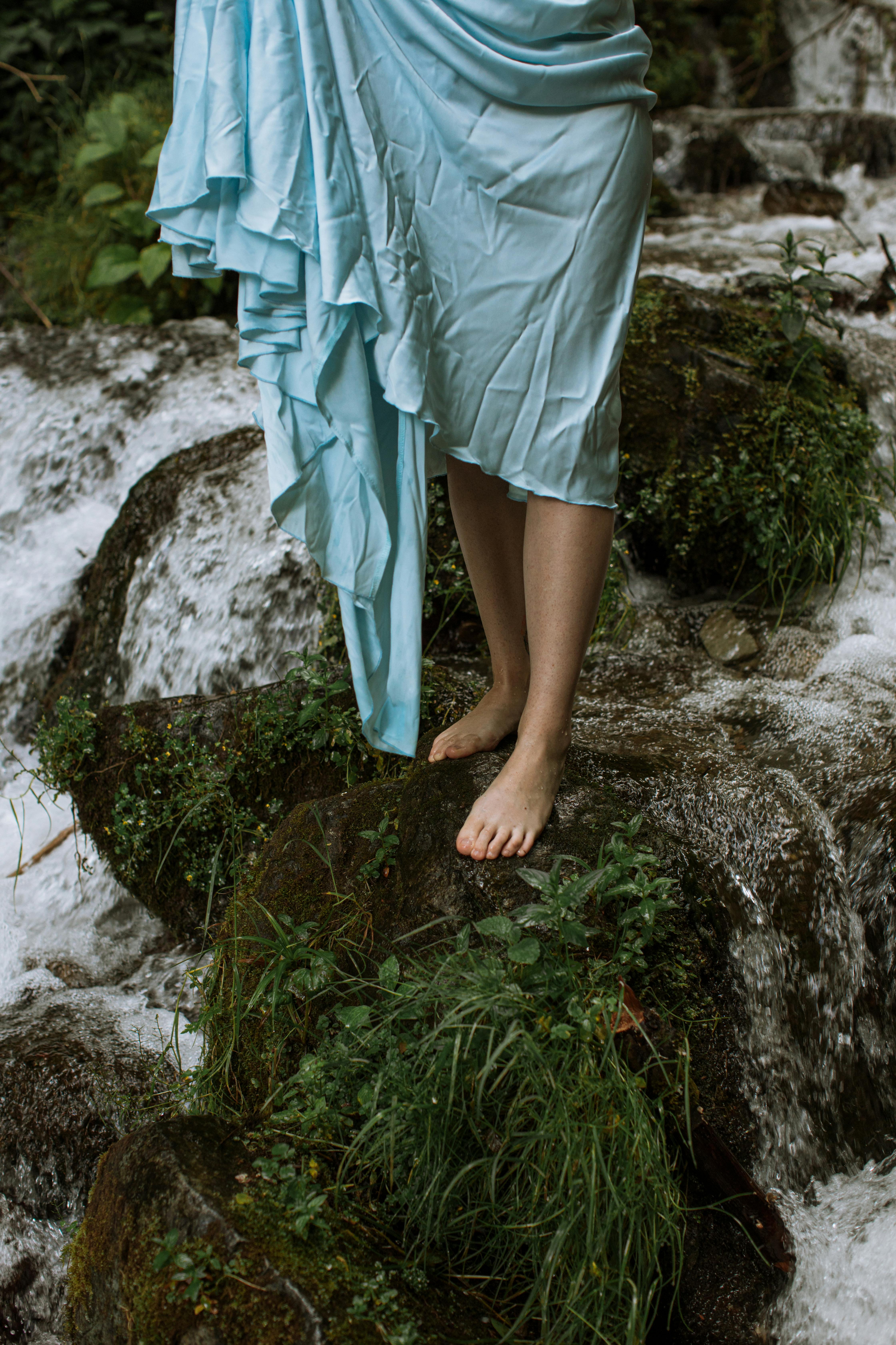 Photo of a Person's Feet on a Rock with Green Moss · Free Stock Photo