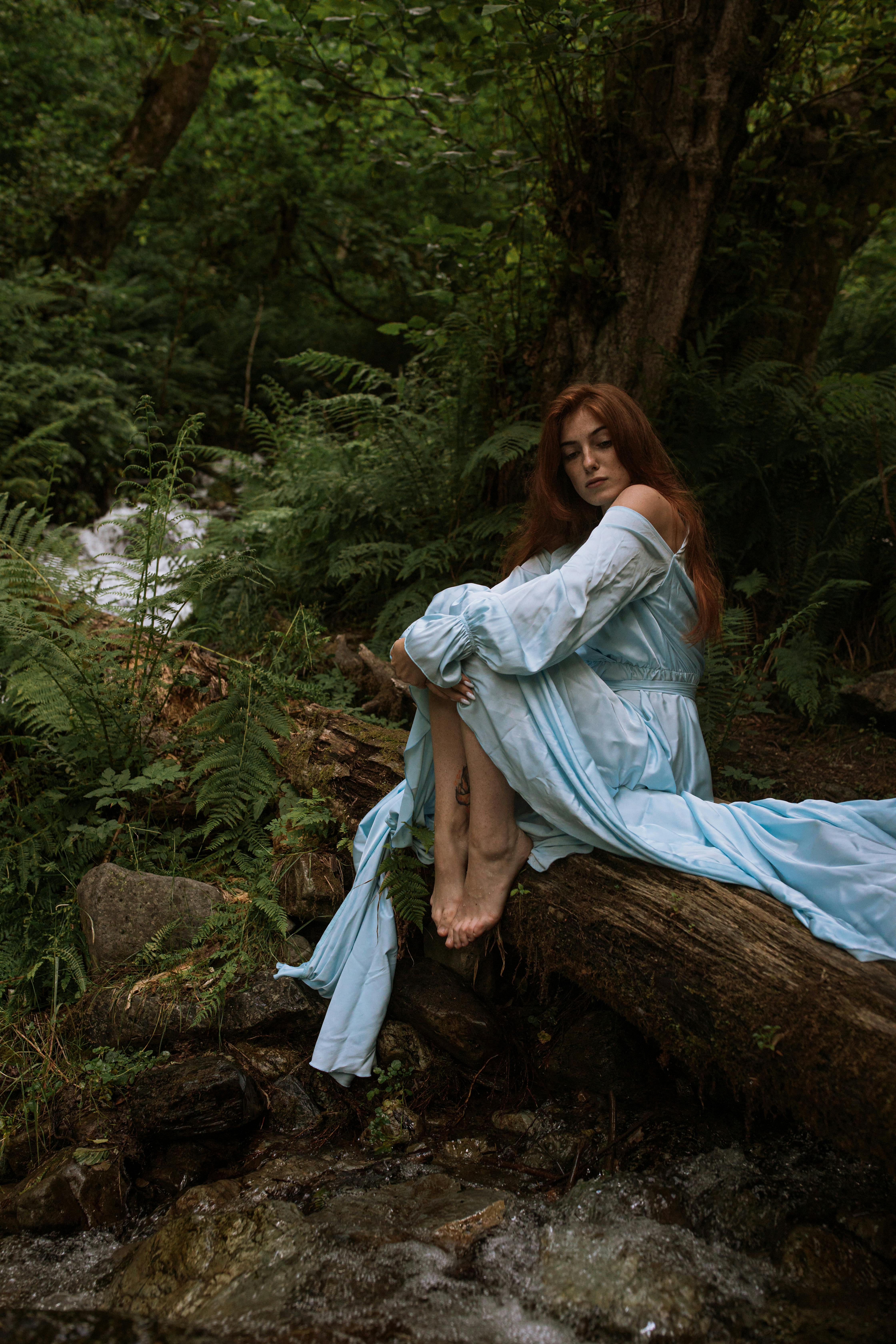 A Woman Sitting on the Tree Log · Free Stock Photo