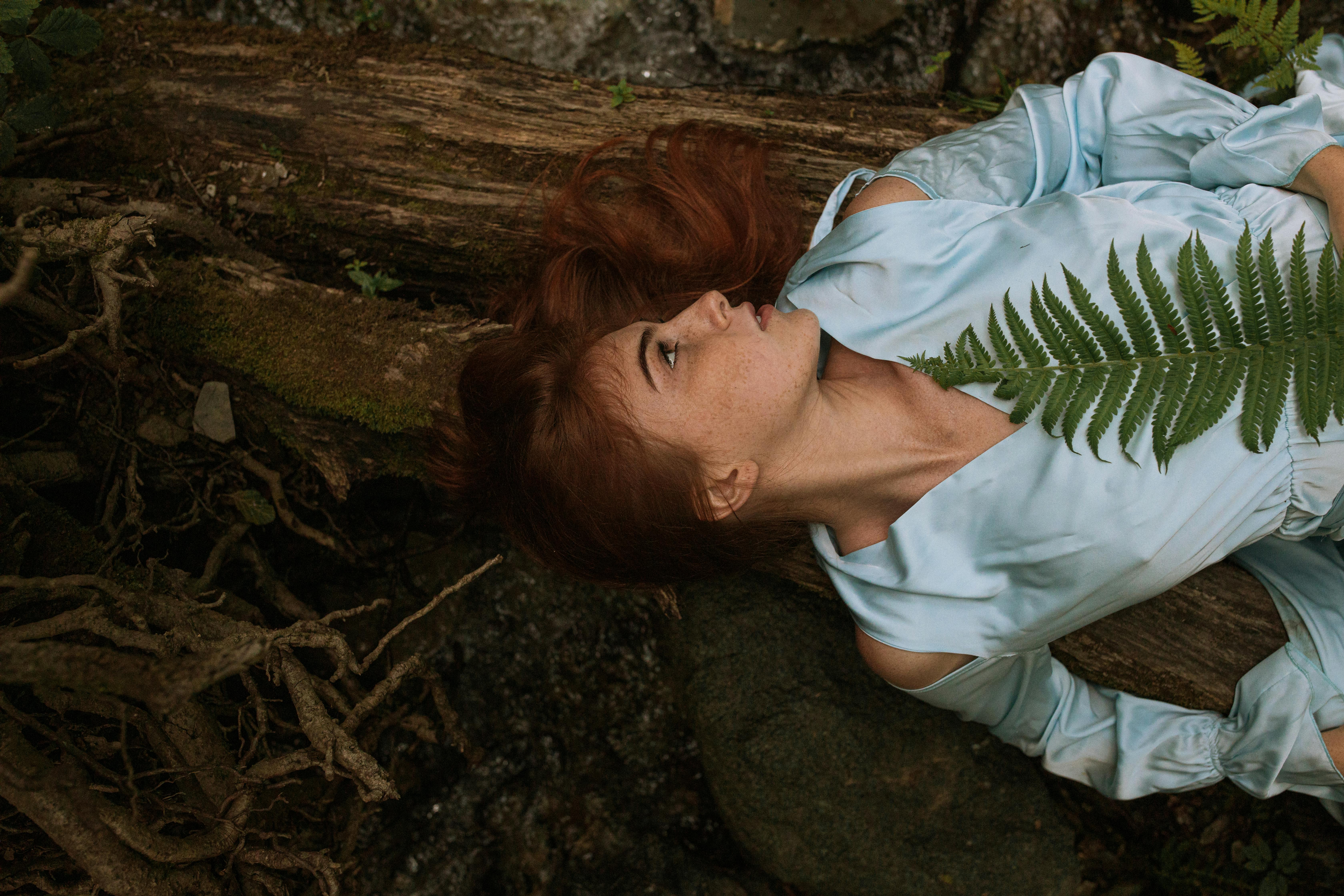 A Woman Lying on the Tree Log · Free Stock Photo