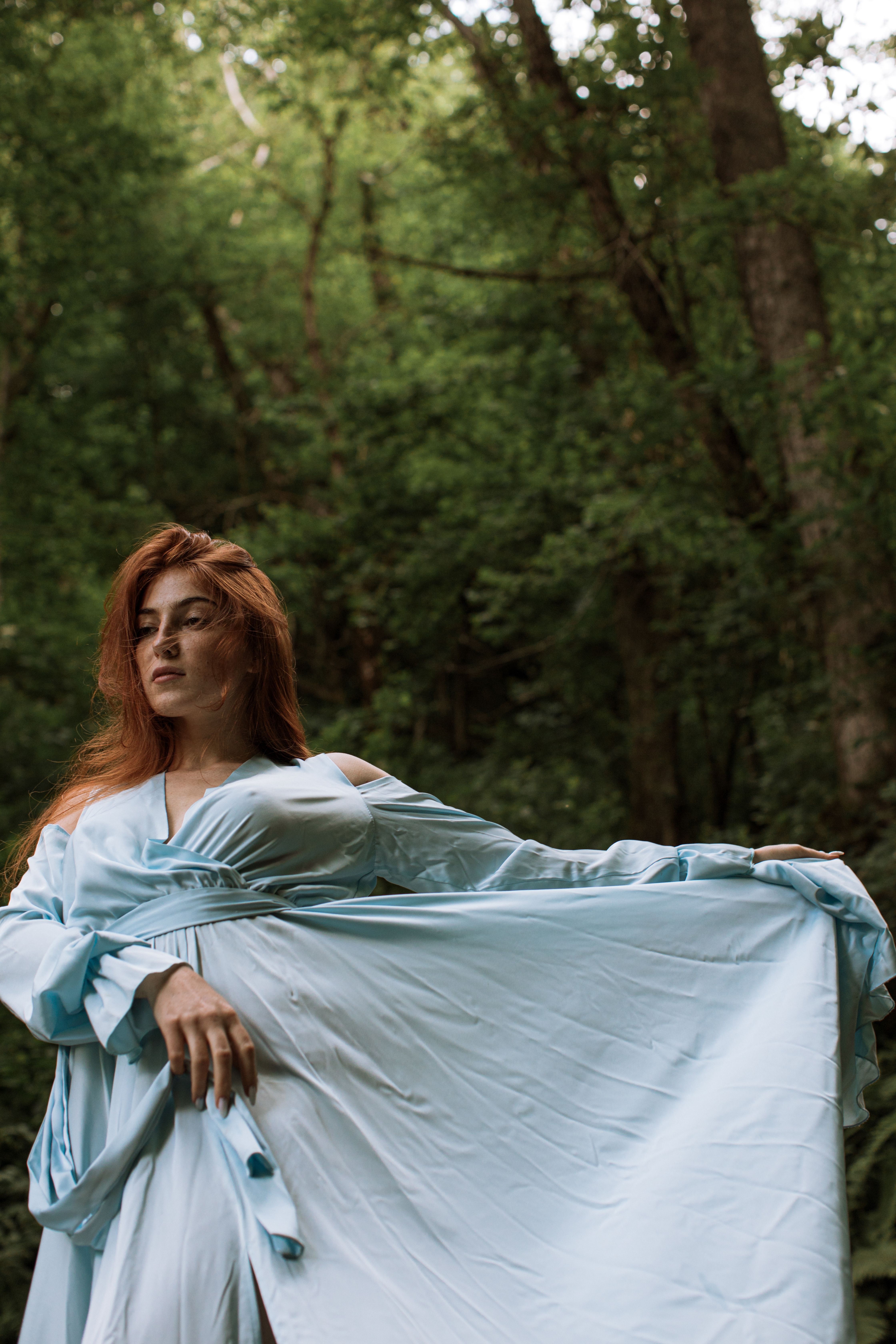 Woman in the Forest Holding her Blue Dress · Free Stock Photo