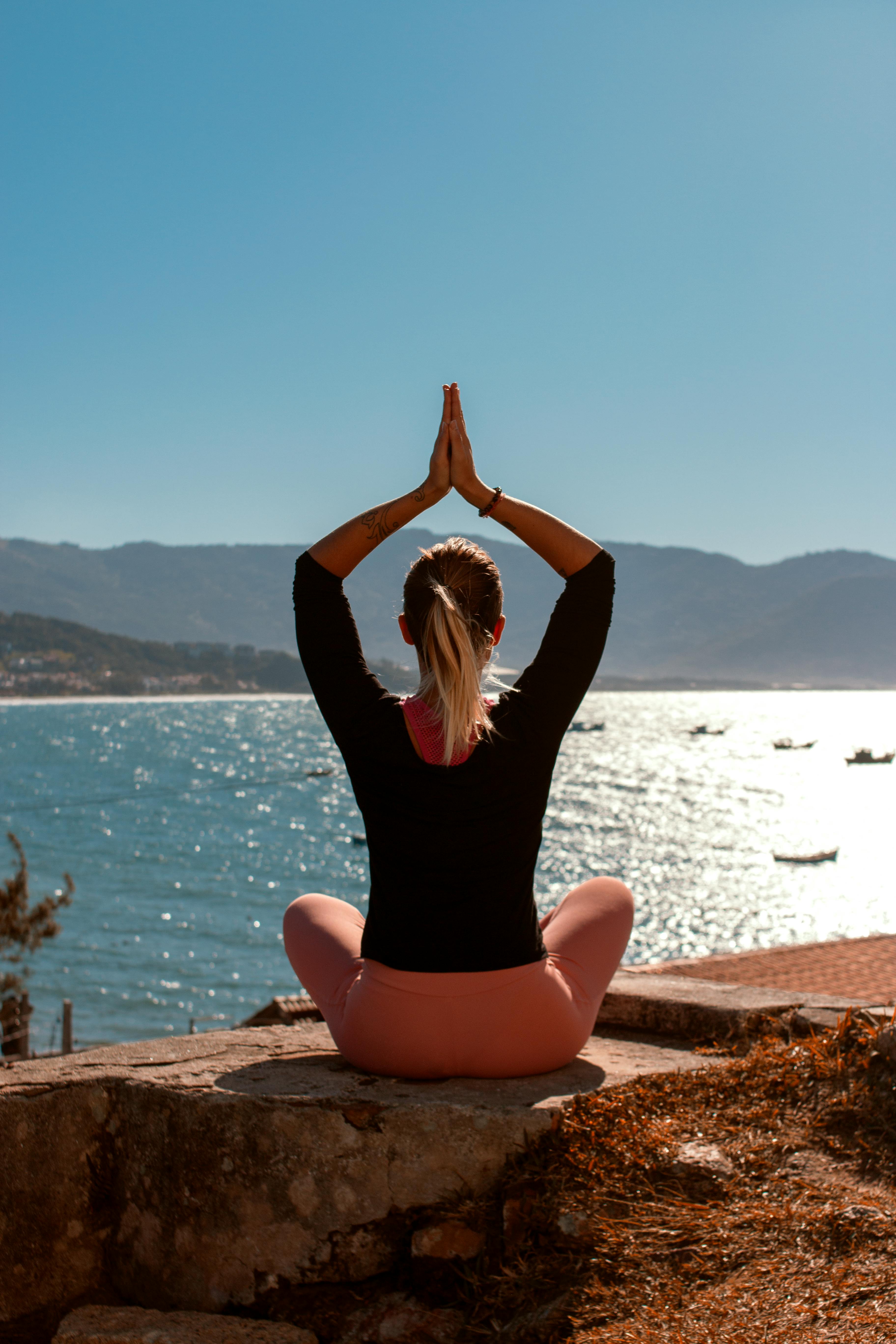 Back View of a Woman Doing a Yoga Pose with Her Hands Together · Free ...