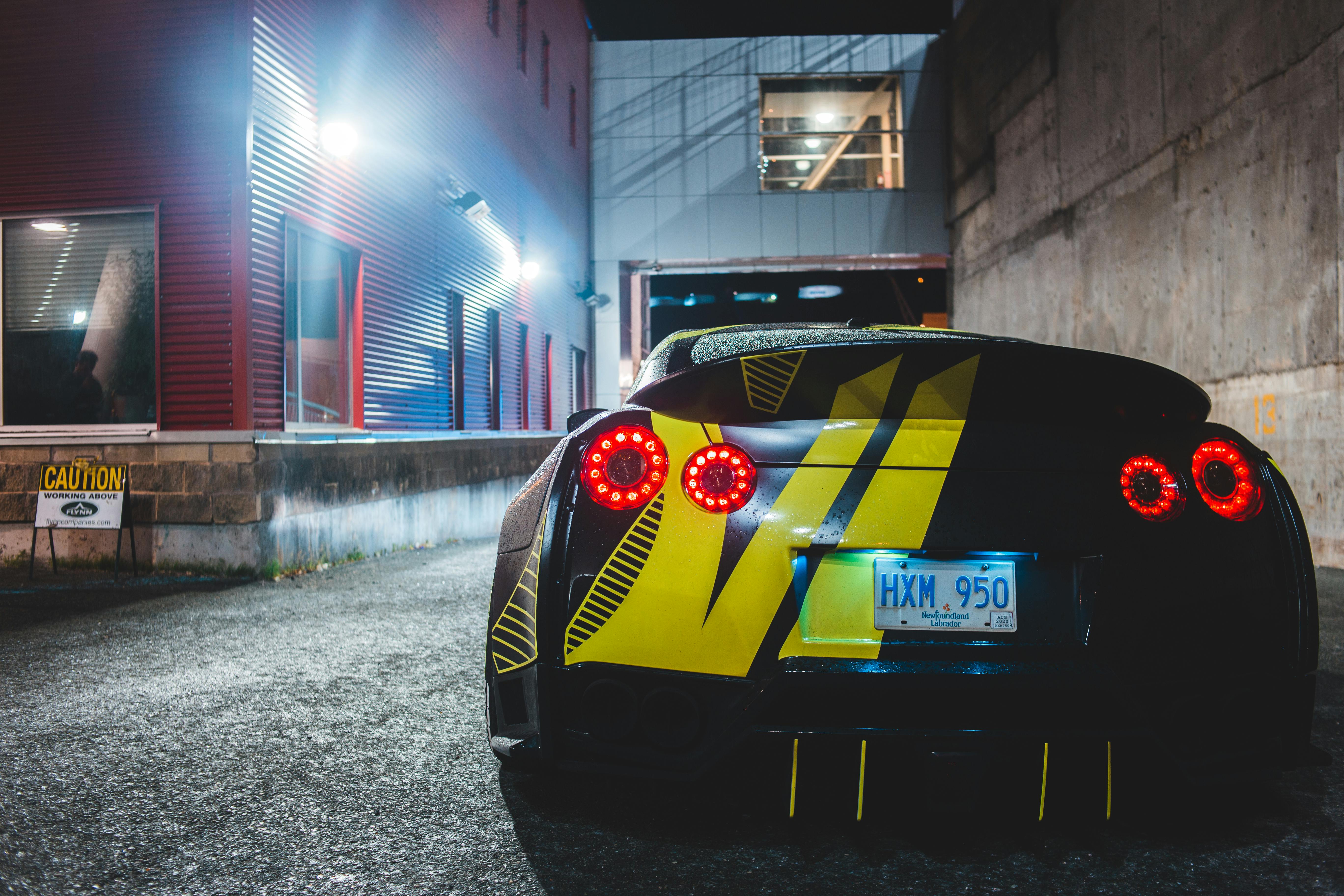 Luxury sports auto on city street at night · Free Stock Photo