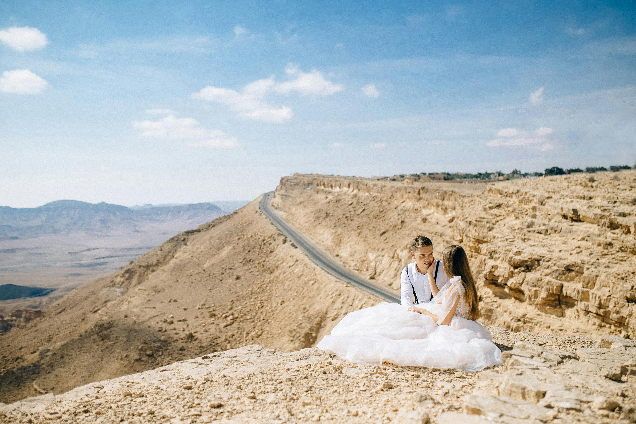 Back View of a Woman Sitting on the Cliff Overlooking the Canyon ...