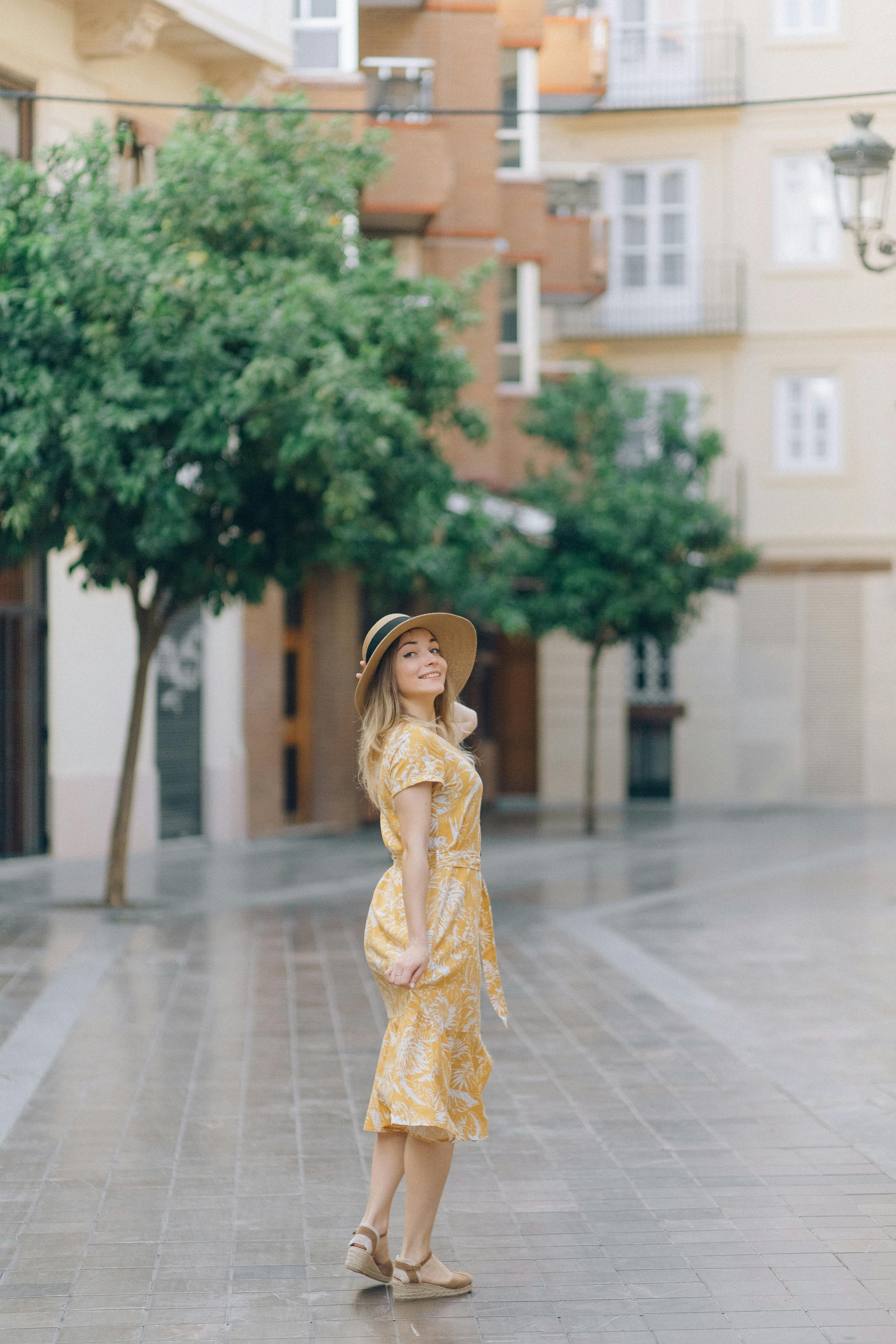 Woman in Yellow Dress Looking Back · Free Stock Photo