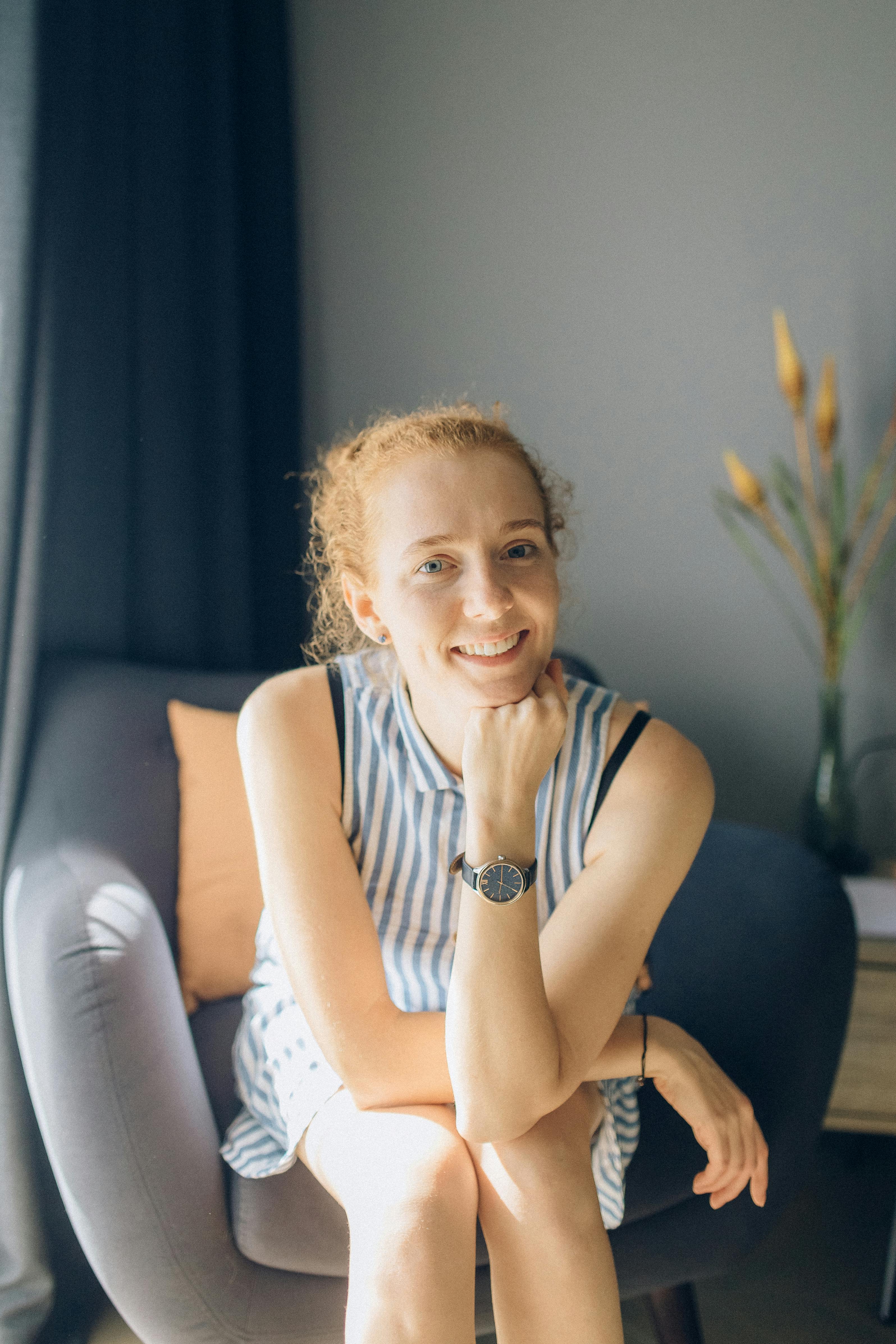 Pretty Woman Sitting on Chair while Looking at Camera · Free Stock Photo