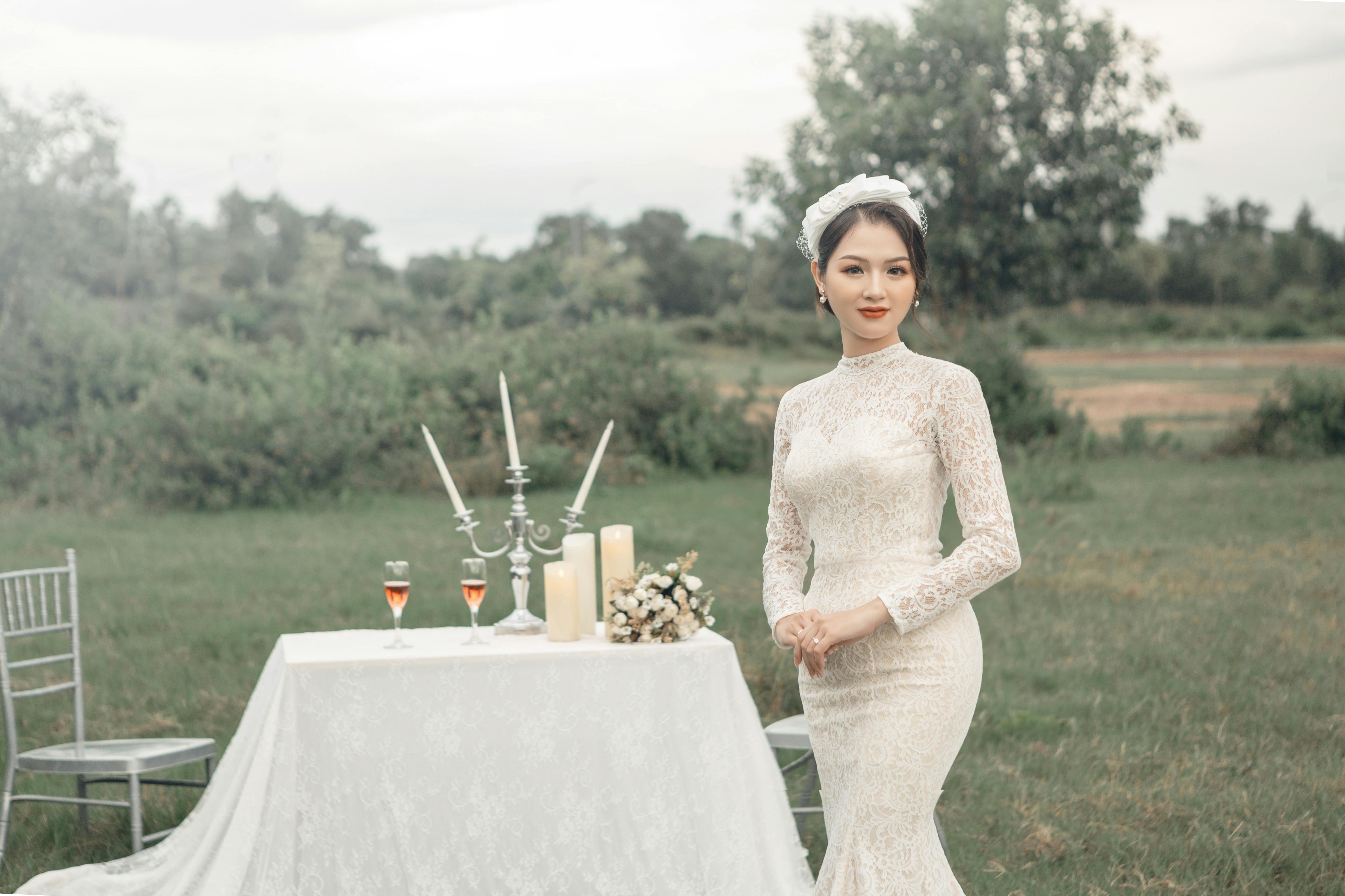 Bride Standing Next to Table at Outdoor Wedding · Free Stock Photo