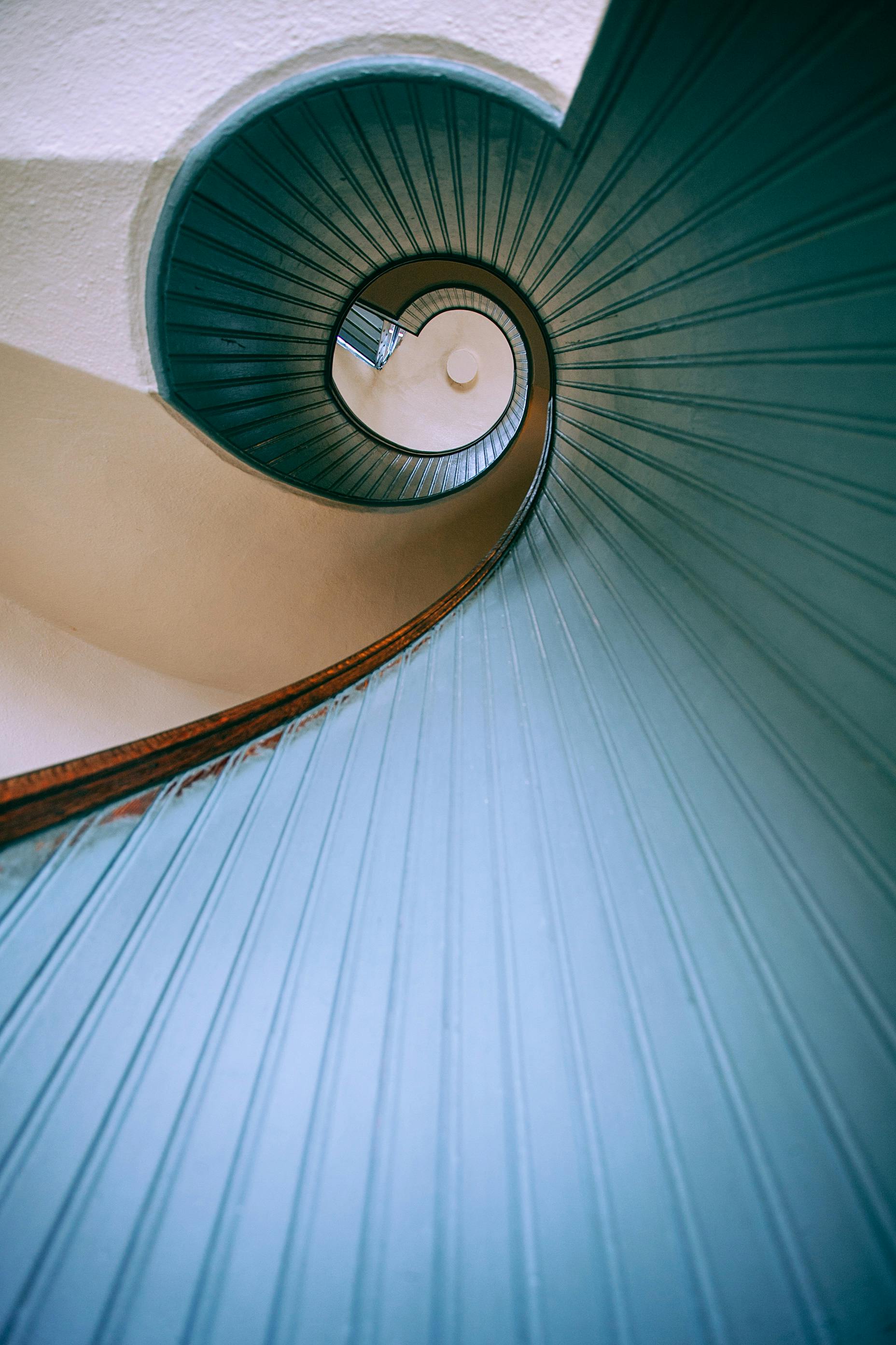 Spiral staircase with concrete blue railings · Free Stock Photo