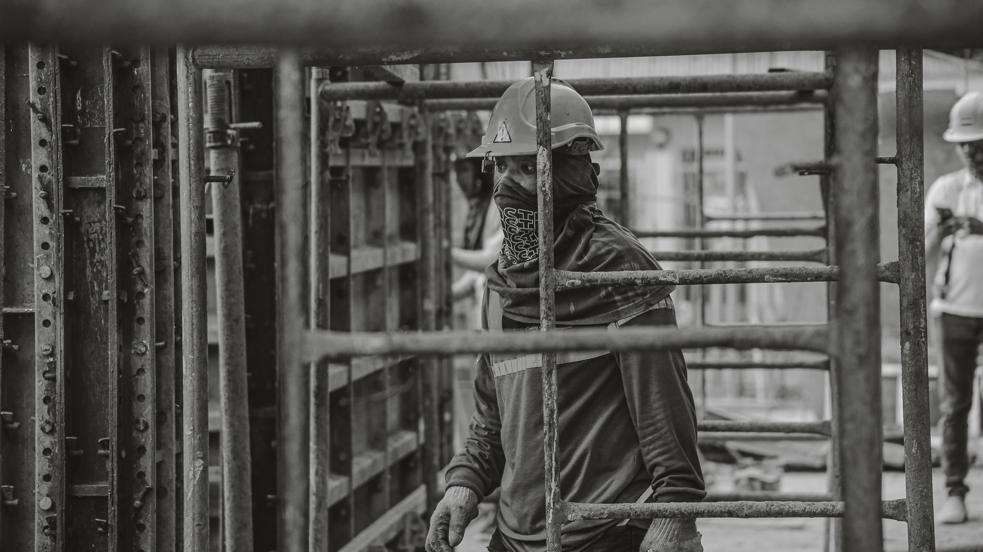 Grayscale Photo of a Man Working in Construction · Free Stock Photo