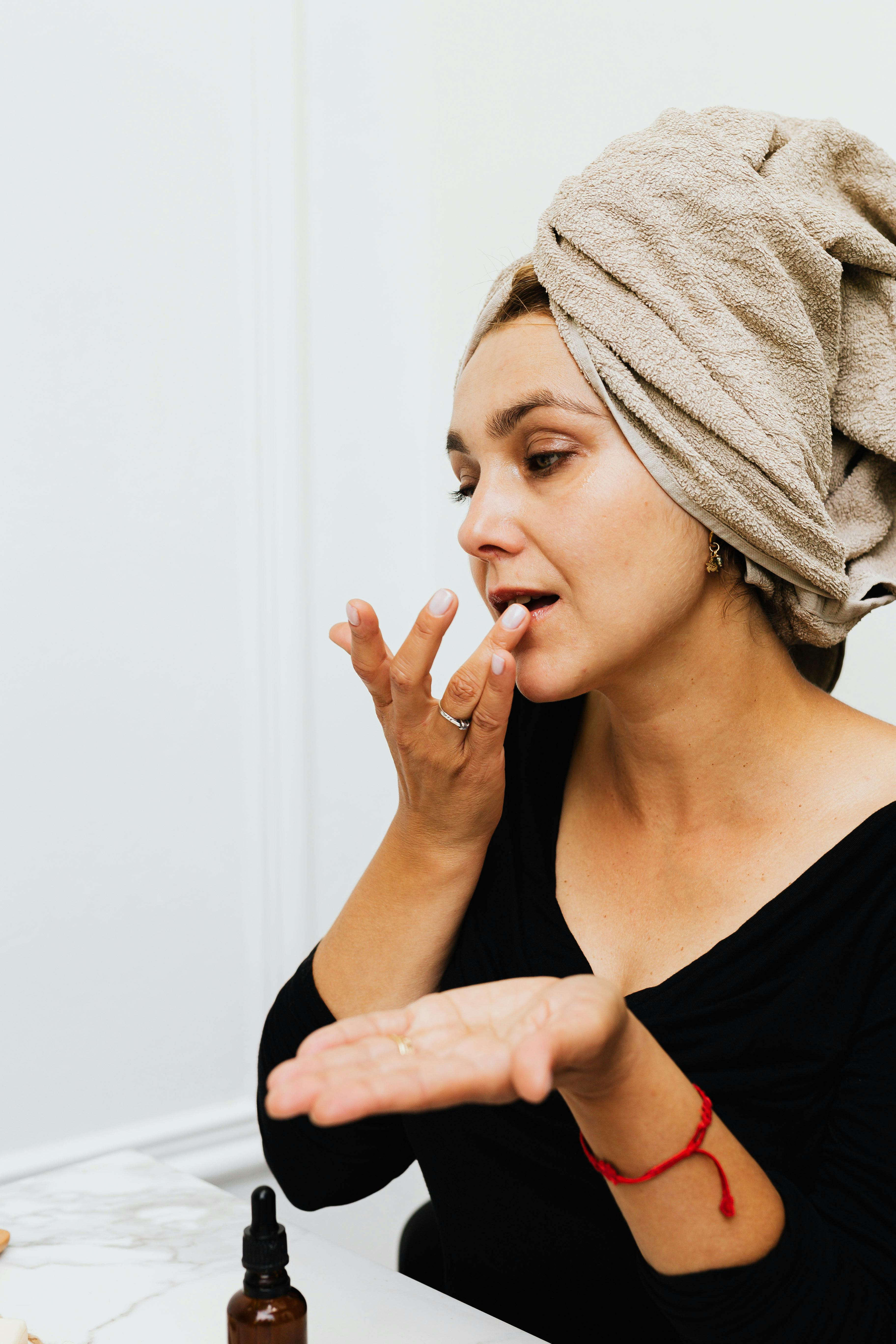 Woman Putting Cream on Lips · Free Stock Photo