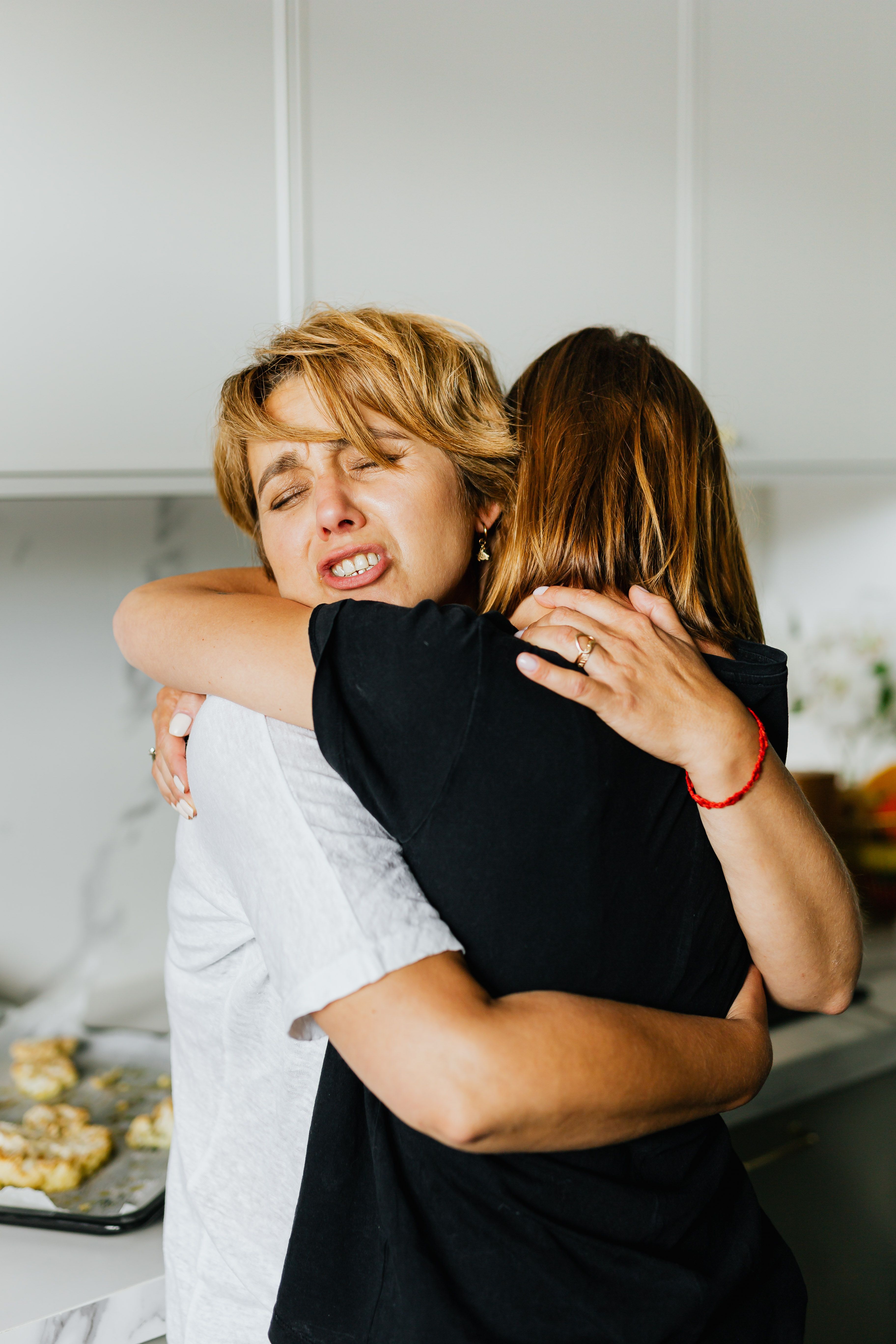 Woman Being Hugged While Making Dinner · Free Stock Photo