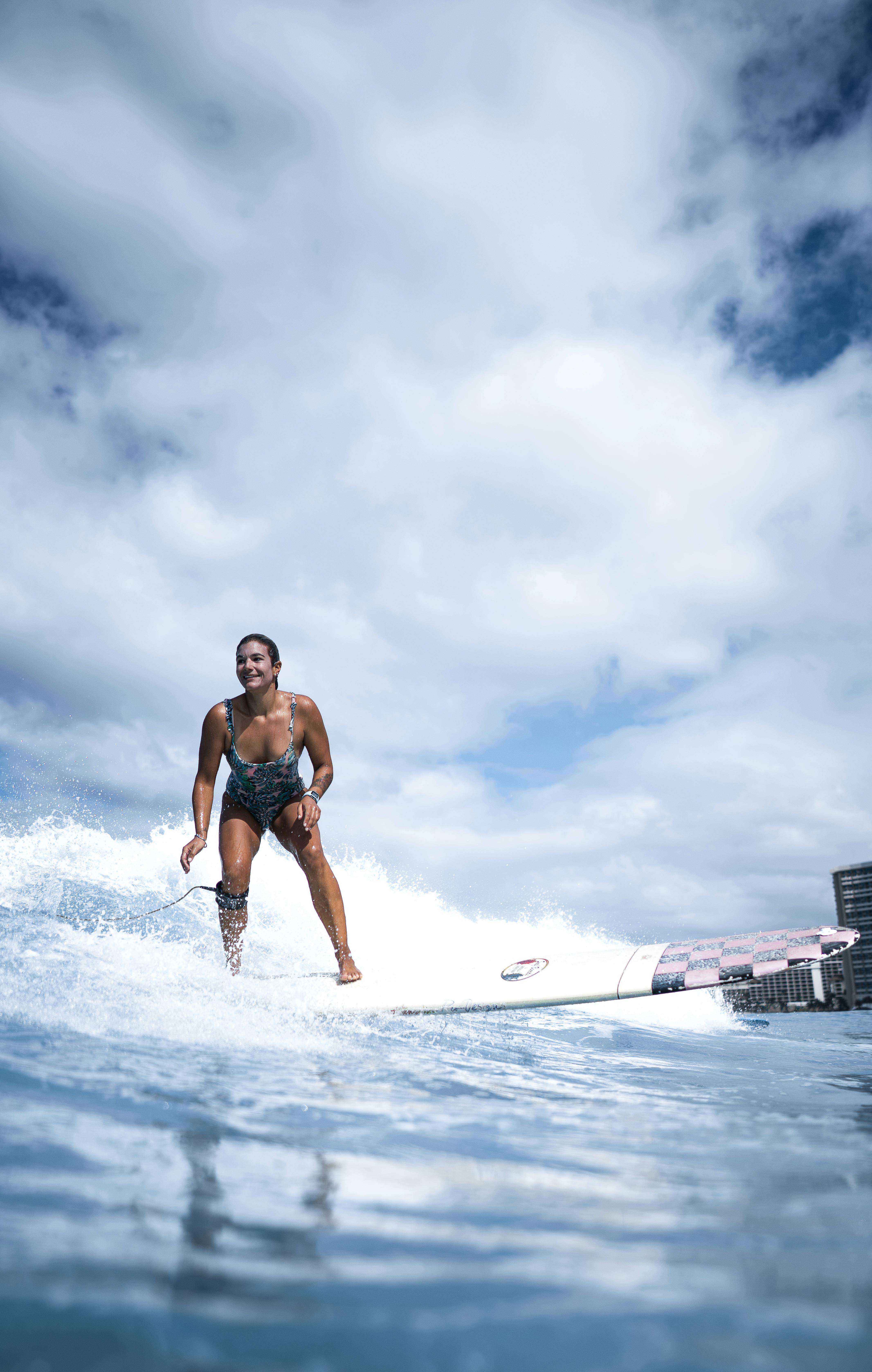 Woman surfing on foamy wave · Free Stock Photo