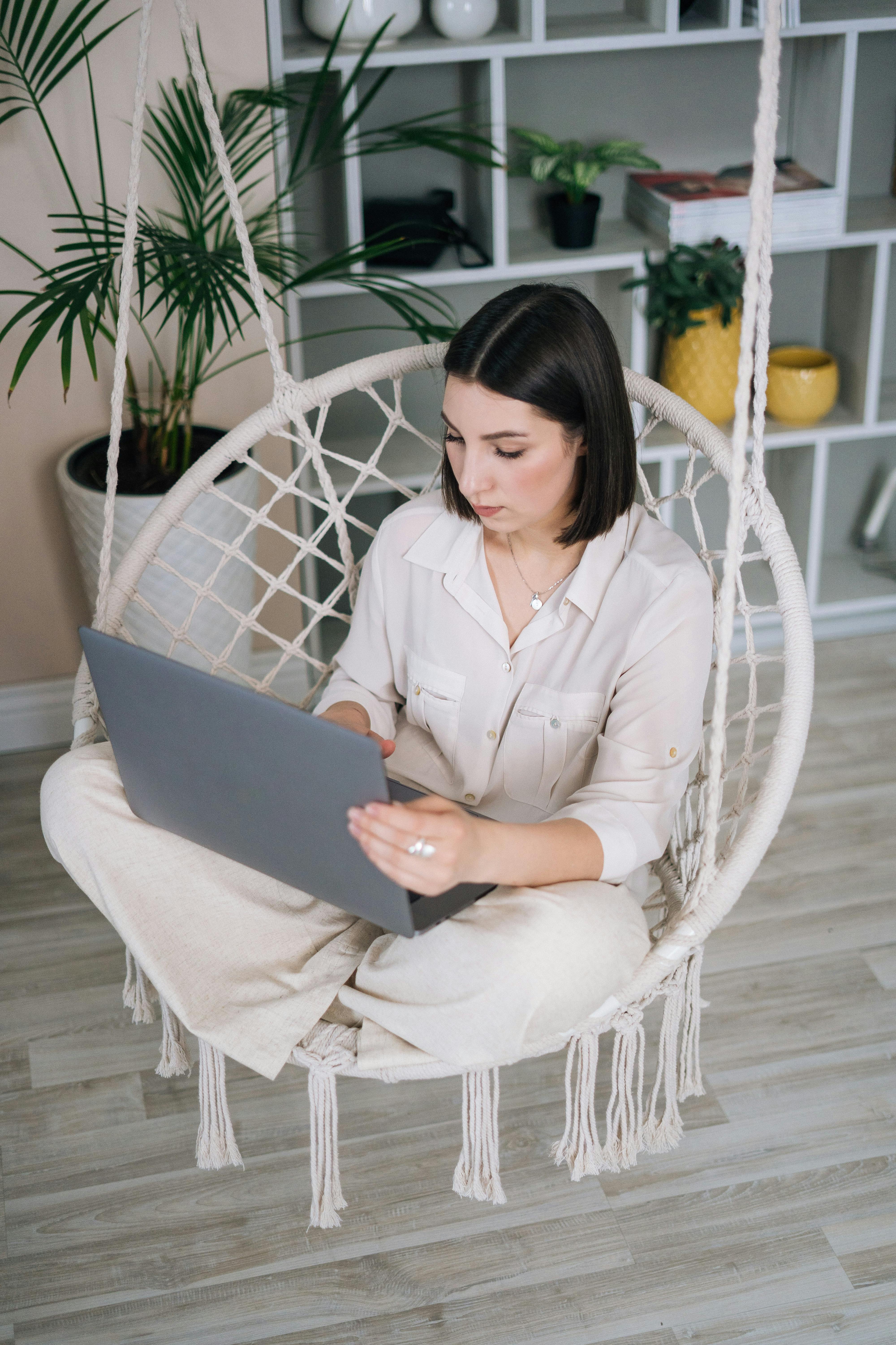 Woman Sitting While Using a Laptop · Free Stock Photo