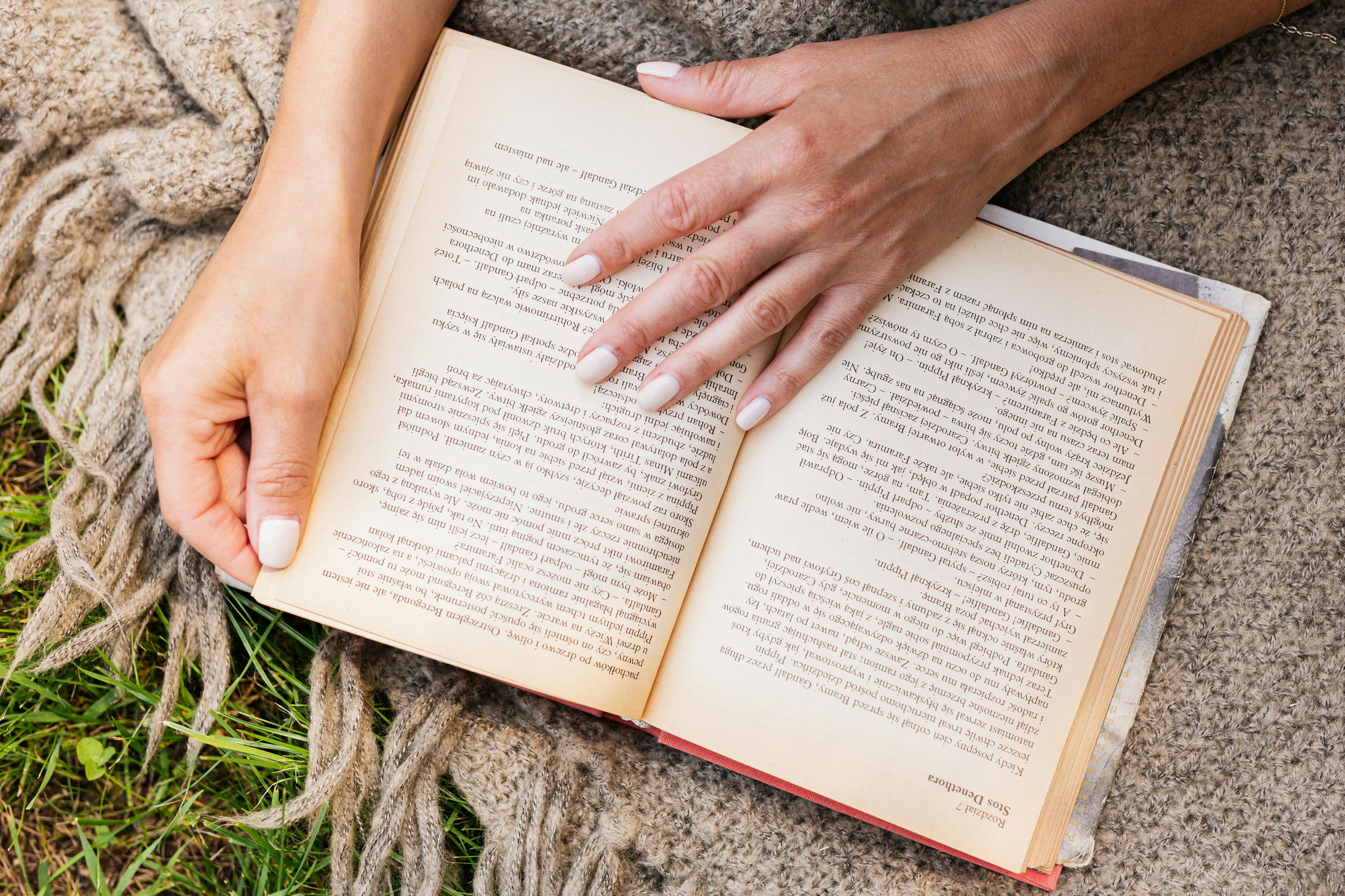 Overhead View of Hands on Book · Free Stock Photo