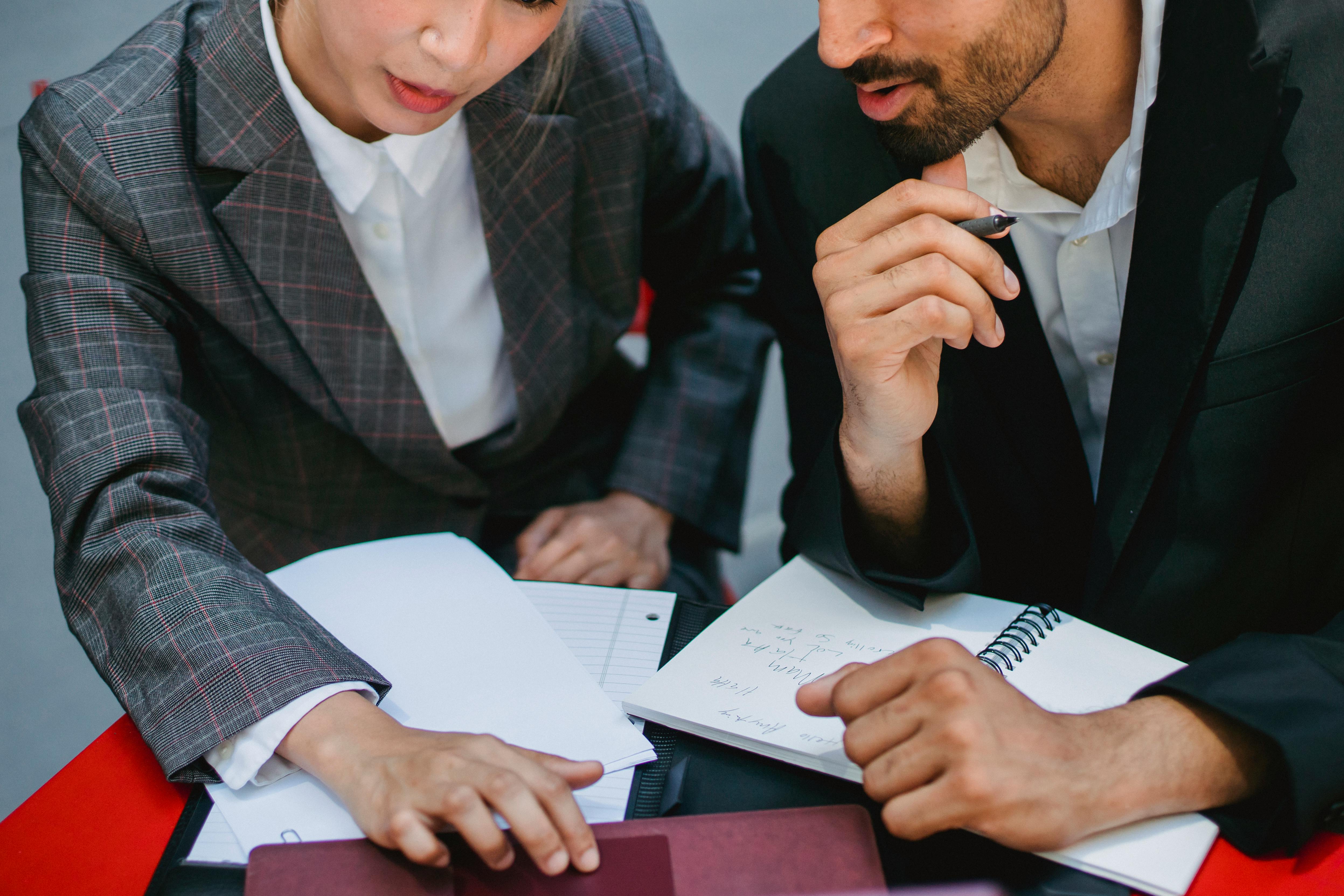 Man and Woman Checking Papers · Free Stock Photo