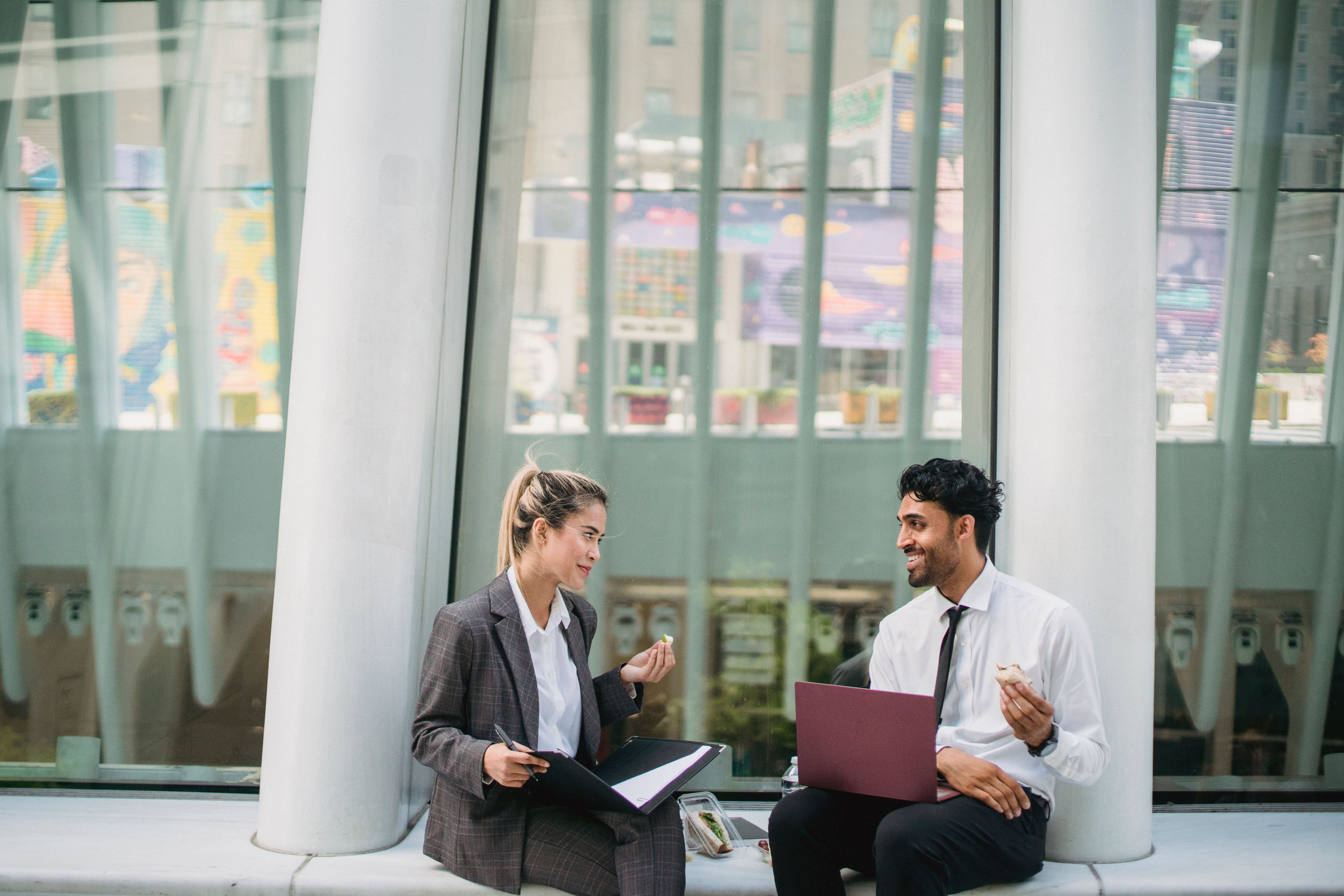 Colleagues Looking at Each Other while Having a Snack · Free Stock Photo