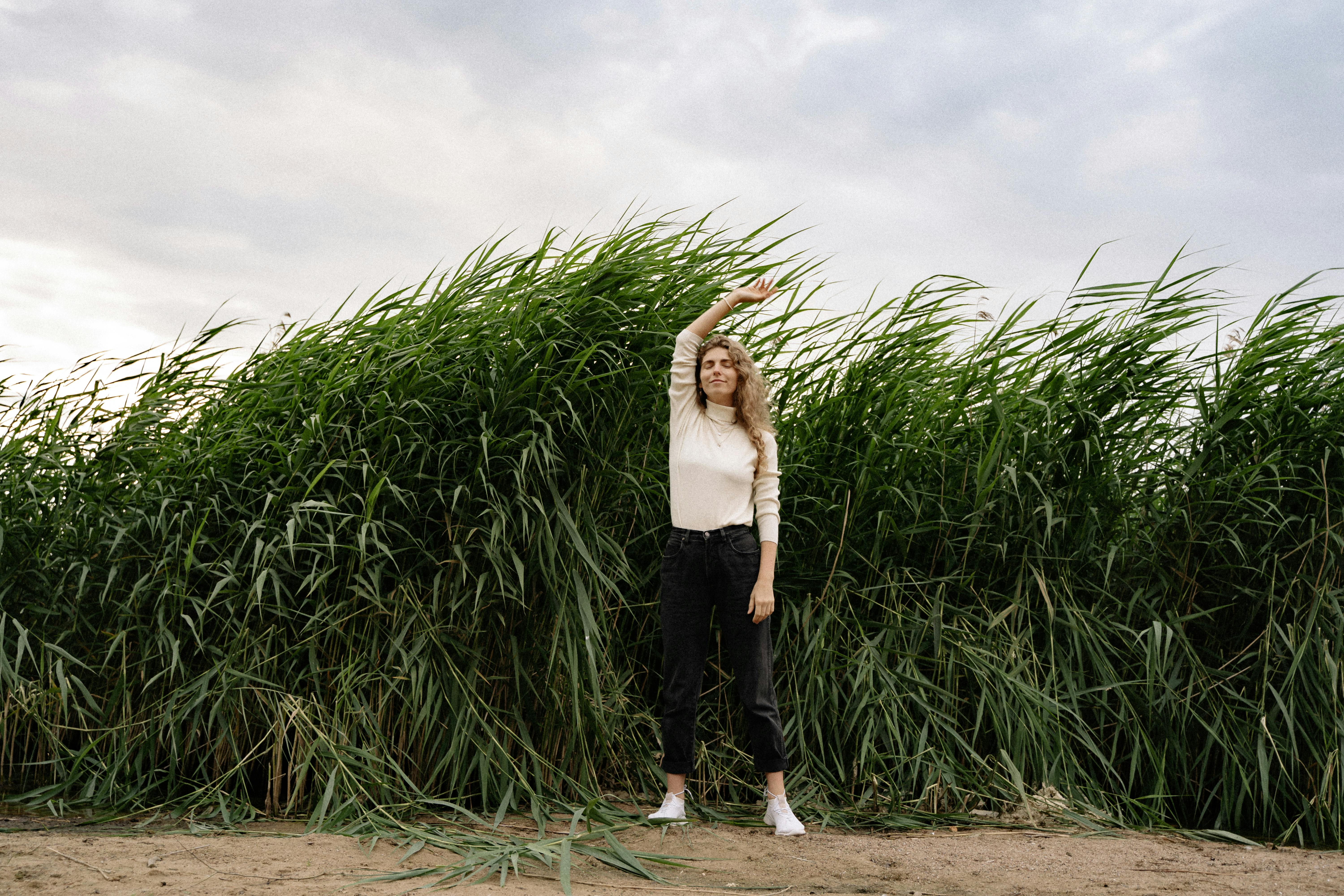 Woman with Rushes behind · Free Stock Photo