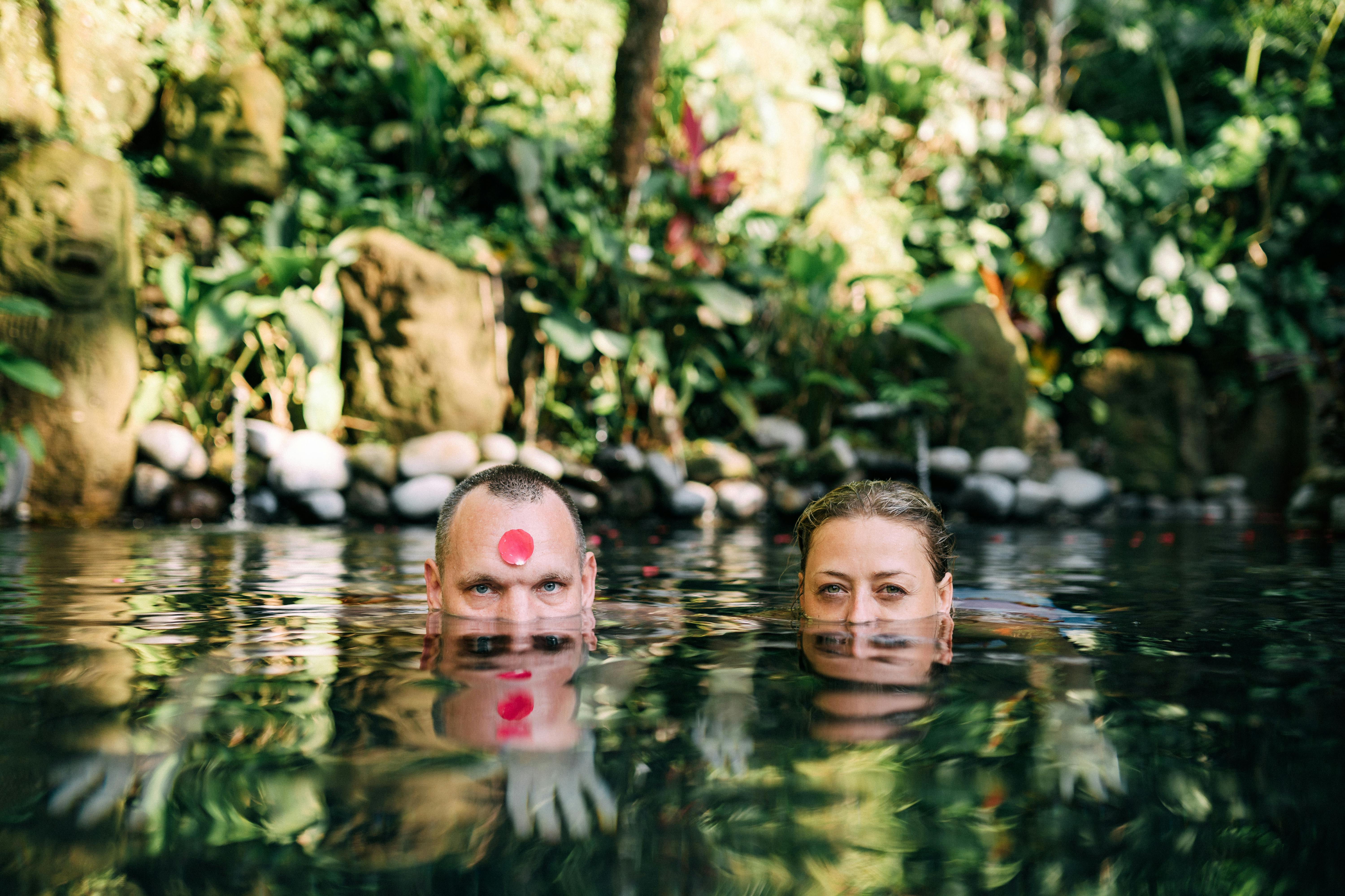 A Man and a Woman Submerged in a Pond · Free Stock Photo